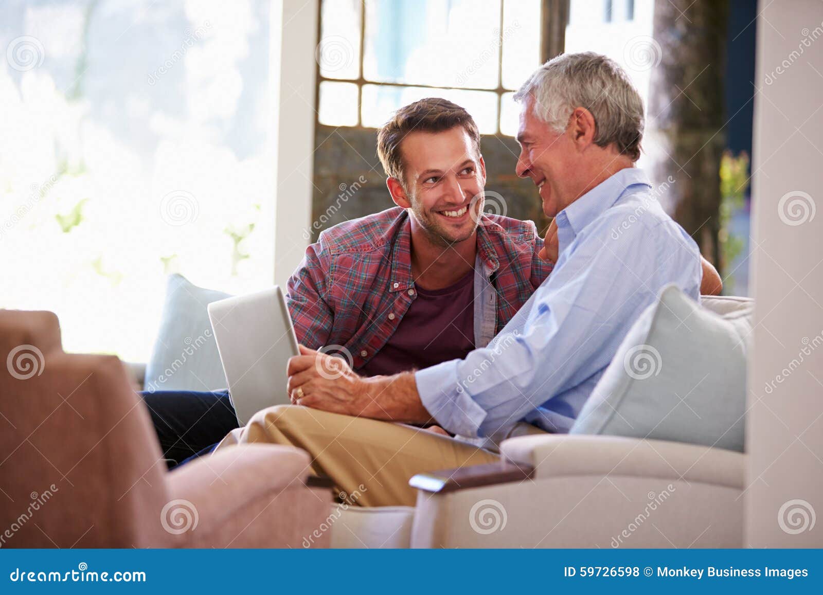 Adult Son Helping Senior Father with Computer at Home Stock Photo ...
