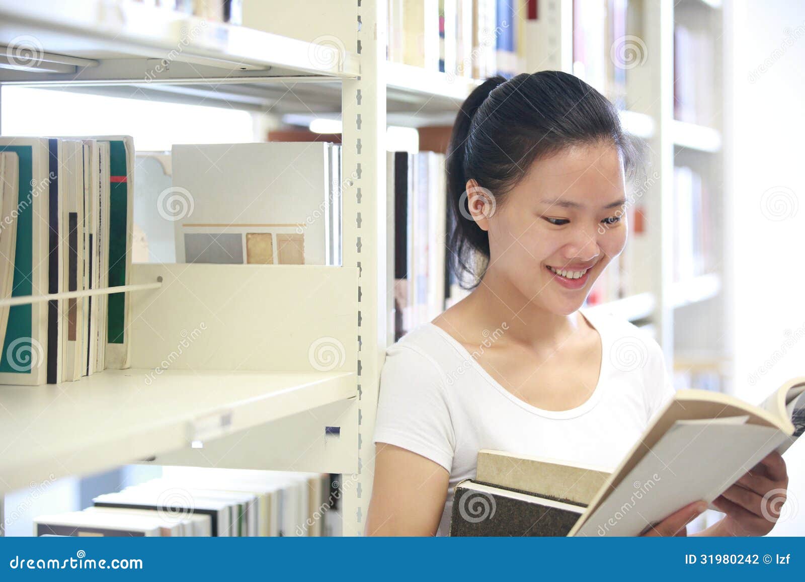 Adult Student Reading in Libray Stock Photo - Image of leaning, casual ...