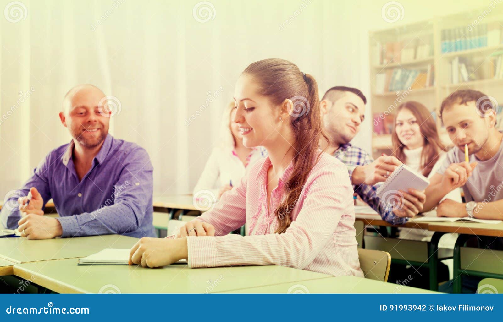 Adult Students Writing in Classroom Stock Photo - Image of clothes ...