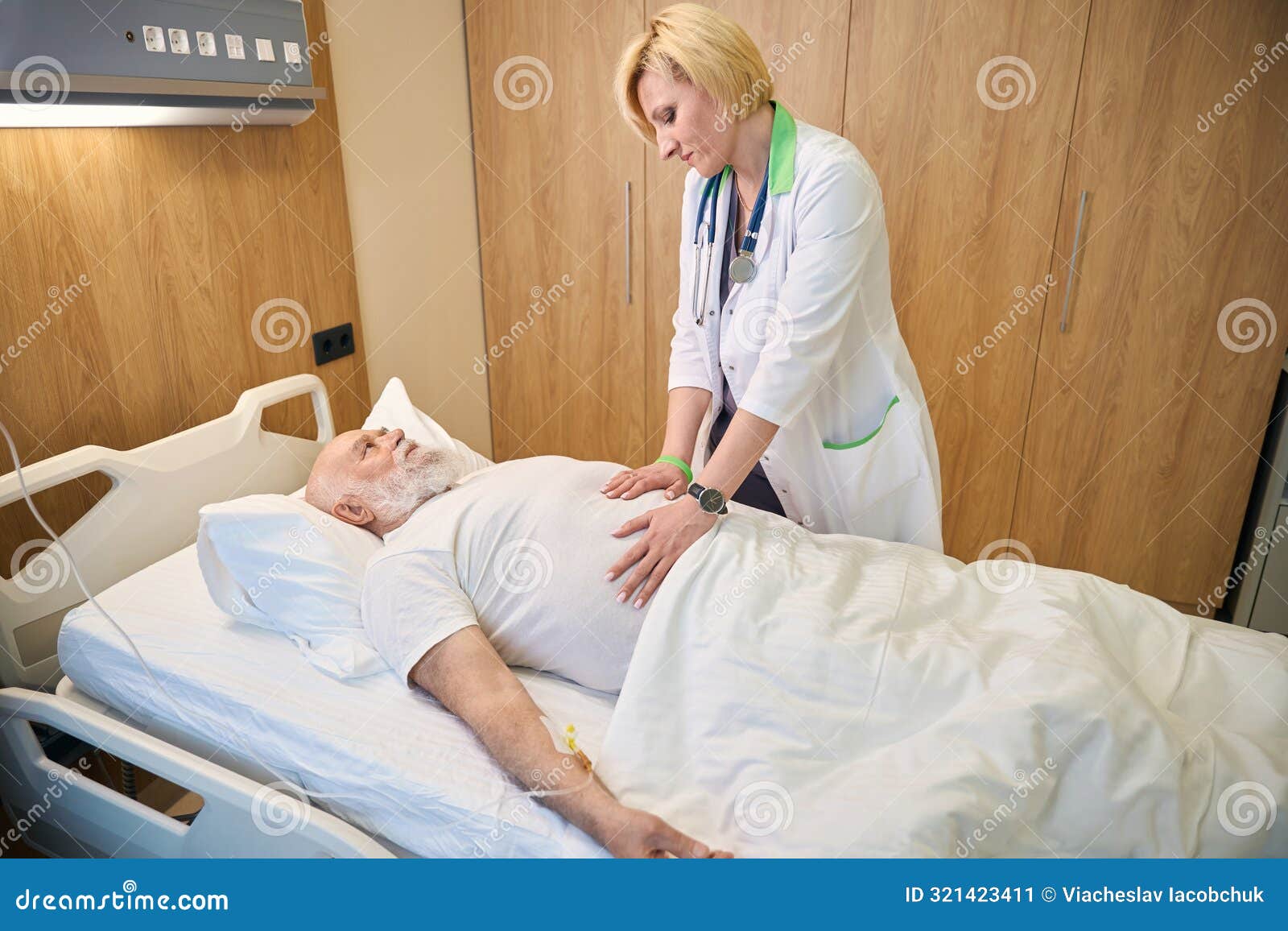 Female Doctor Examining The Stomach Of Male Patient Stock Image Image