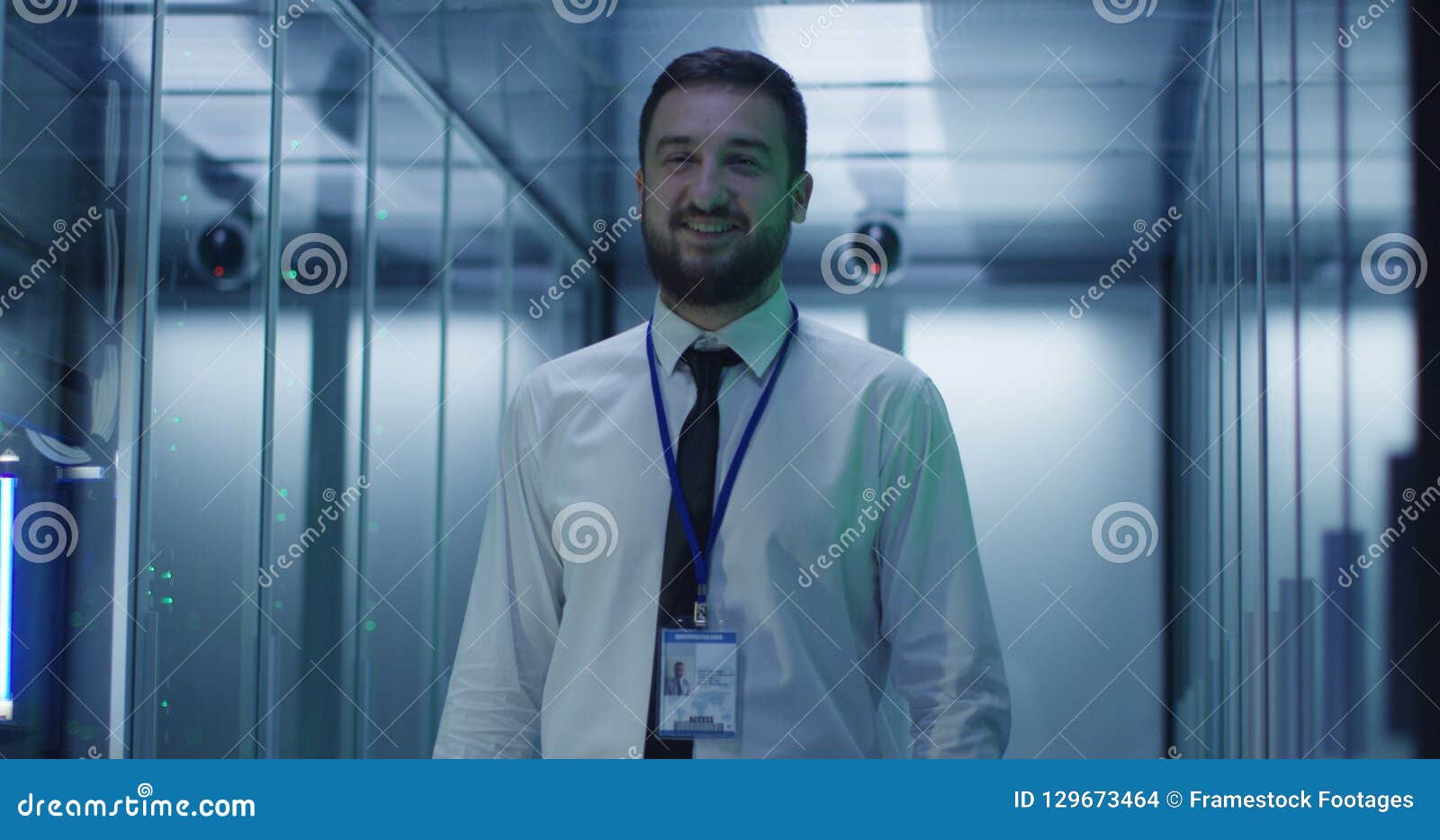 Smiling Engineer in Corridor of Data Center Stock Photo - Image of ...