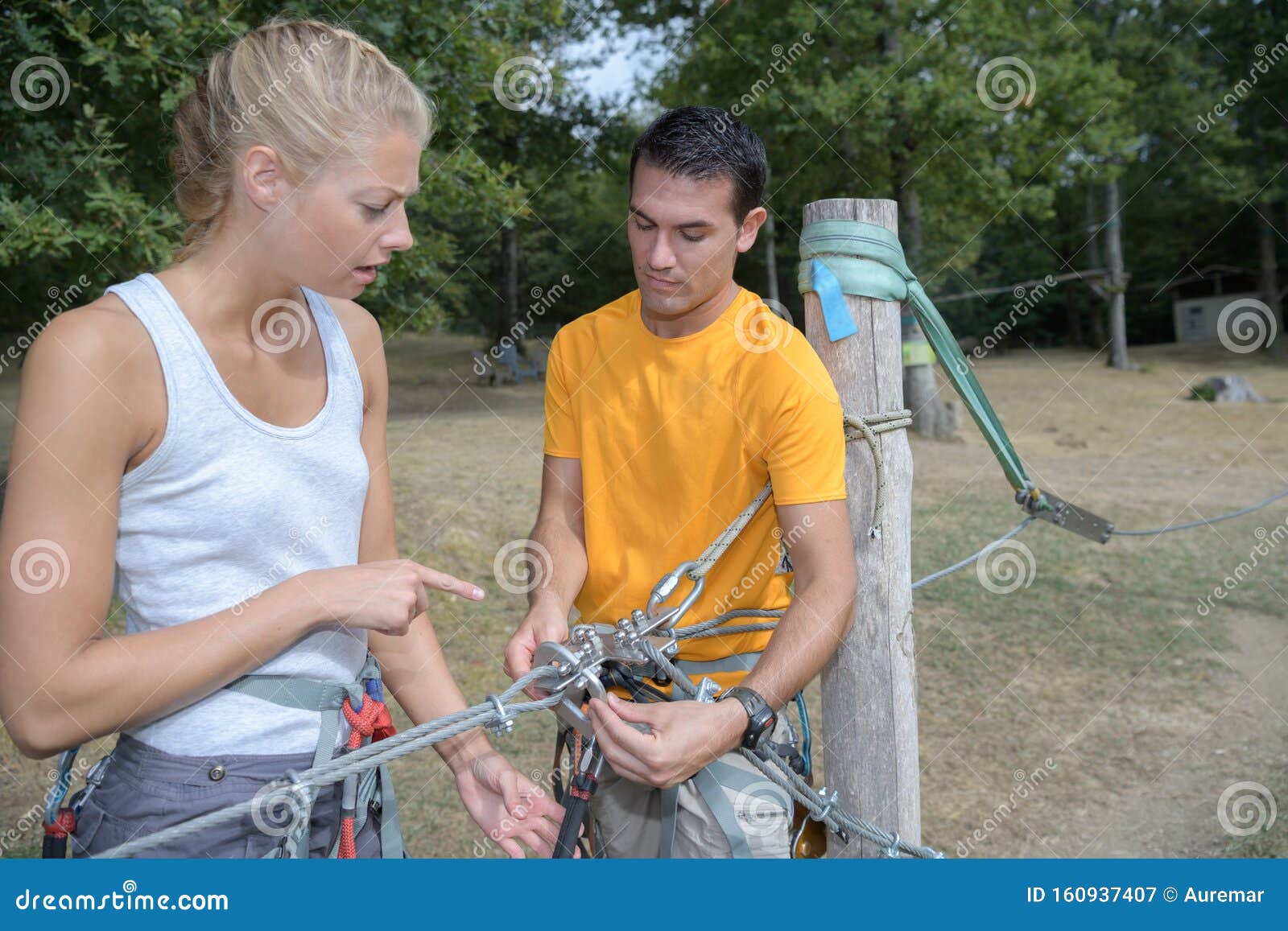 Adults Attaching Safety Clips To Zip Wire Stock Image - Image of girl ...