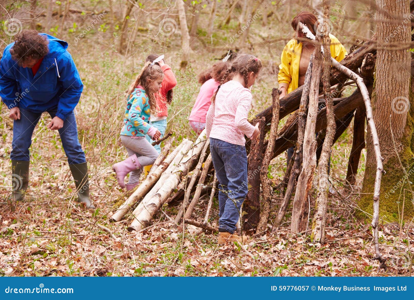 Adults and Children Building Camp at Outdoor Activity Centre Stock ...