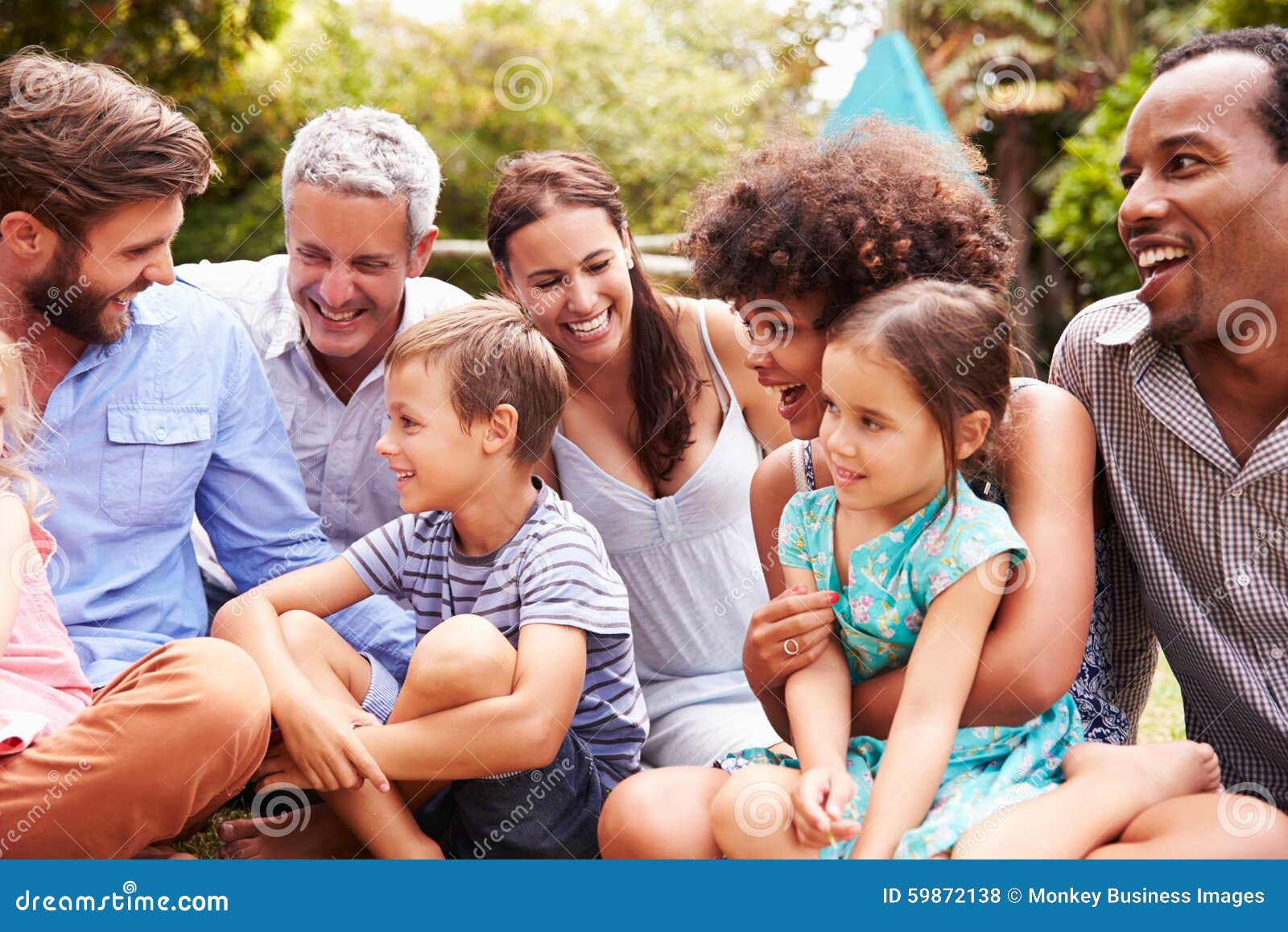 Adults and Kids Sitting on the Grass in a Garden Stock Photo - Image of ...