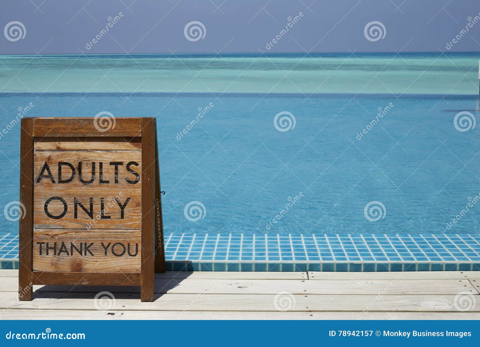 Adults only Sign by an Infinity Pool with Ocean Beyond Stock Image ...