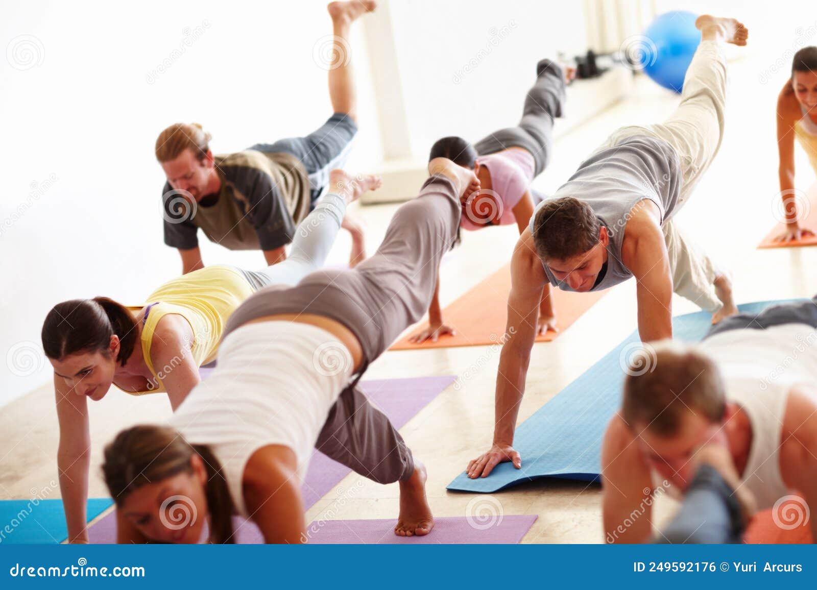 Advanced Yoga Techniques. a Group of People Working Out on Yoga Mats ...
