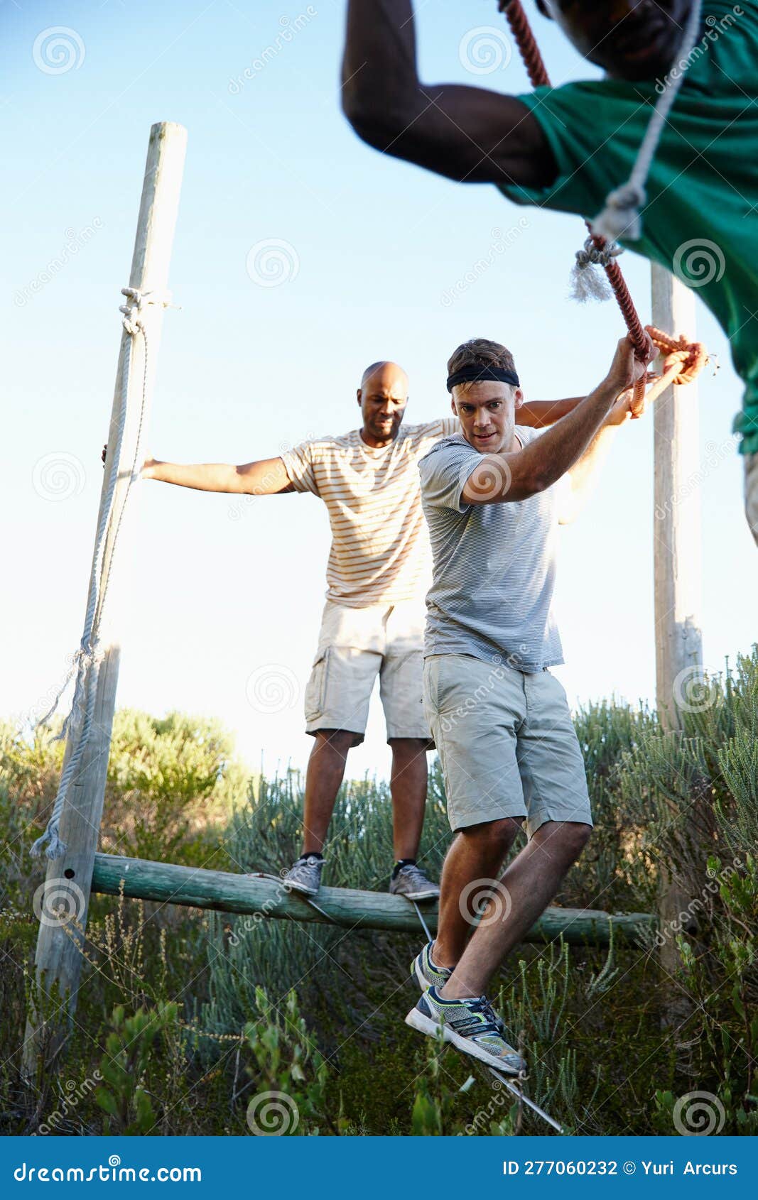 Adventurous Exercise. a Group of Men Going through an Obstacle Course ...
