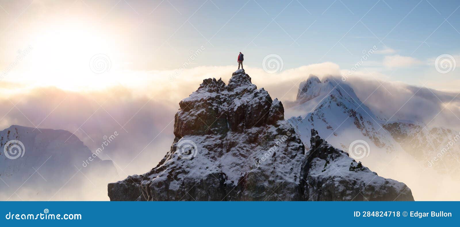 Adventurous Man Standing on Top of Mountain Cliff. Dramatic Extreme ...