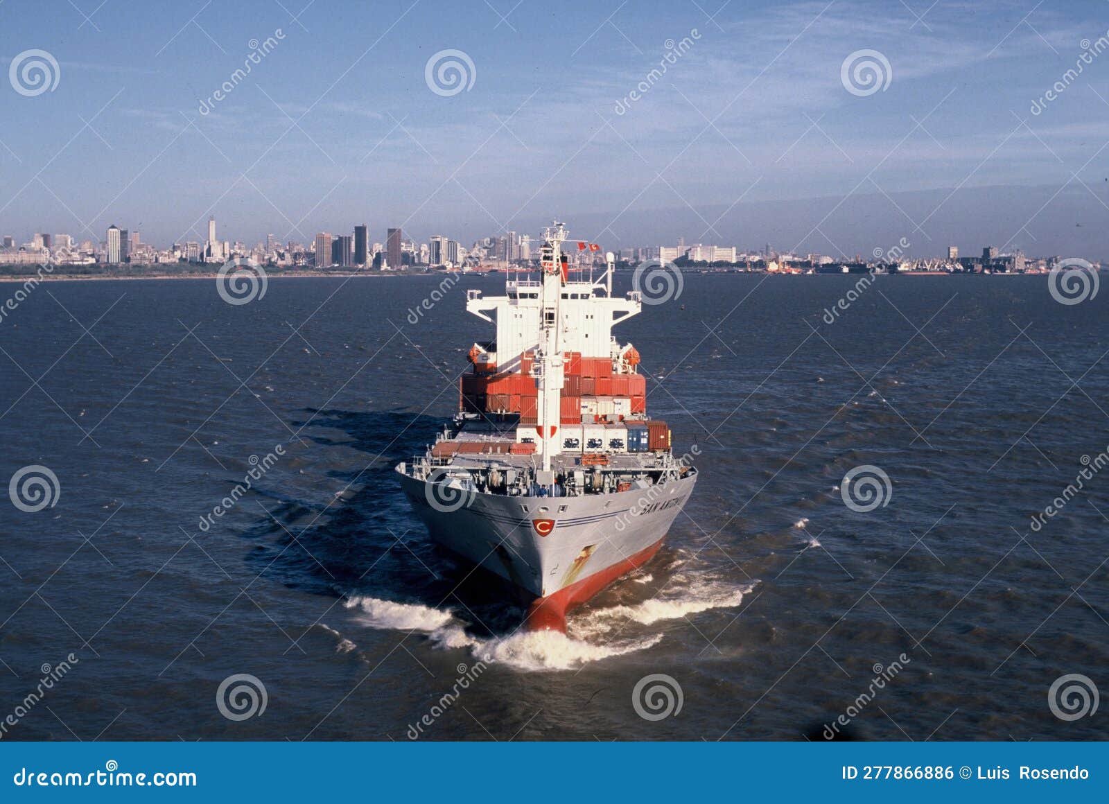 Aerial Front View of a Loaded Container Cargo Vessel Traveling Over ... Aerial Front View of a Loaded Container Cargo Vessel Traveling Over ...