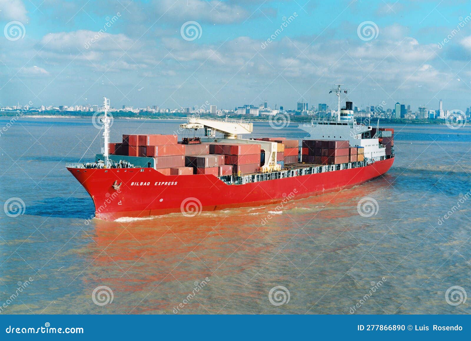 Aerial Front View of a Loaded Container Cargo Vessel Traveling Over ... Aerial Front View of a Loaded Container Cargo Vessel Traveling Over ...