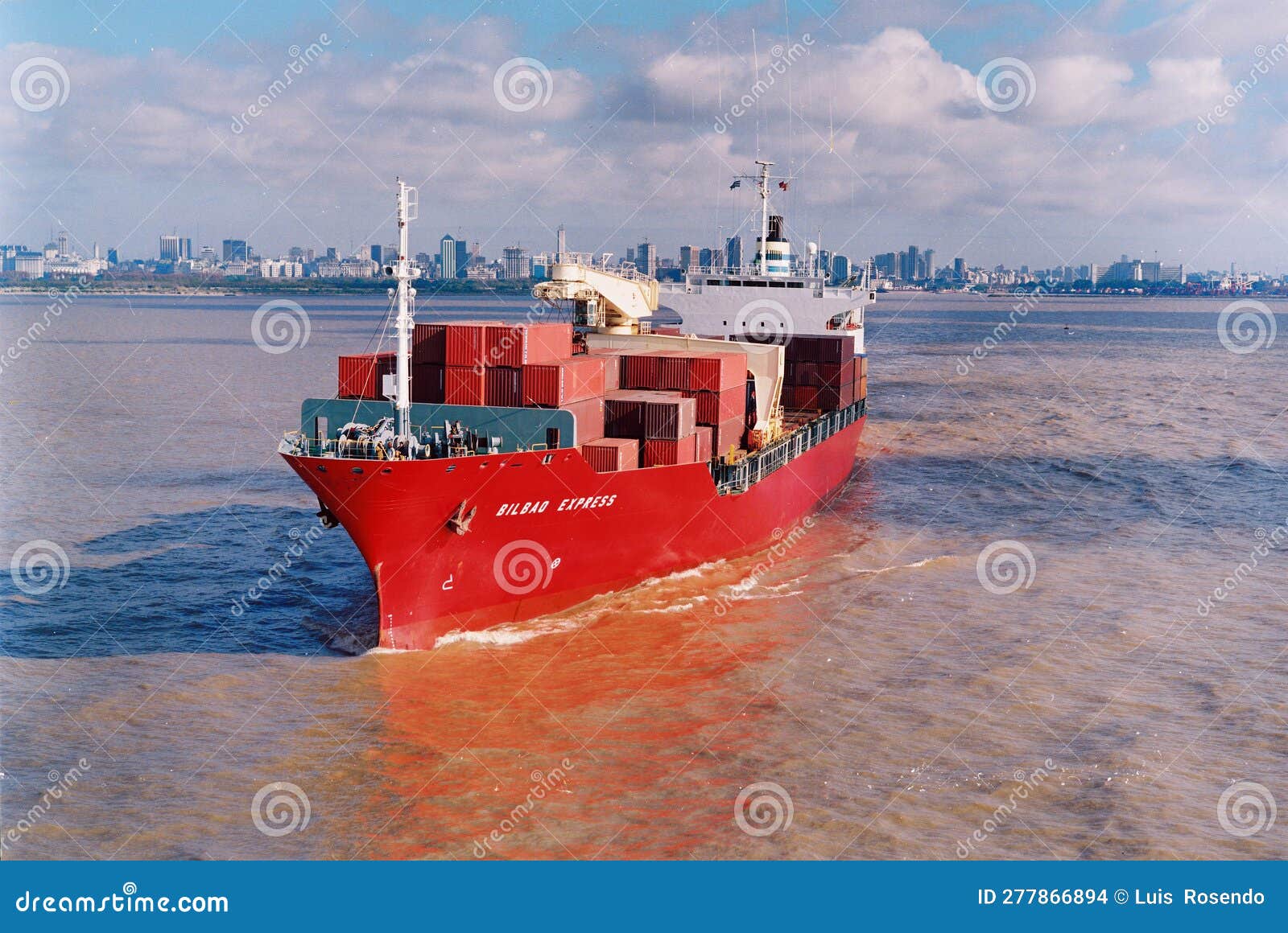 Aerial Front View of a Loaded Container Cargo Vessel Traveling Over ... Aerial Front View of a Loaded Container Cargo Vessel Traveling Over ...
