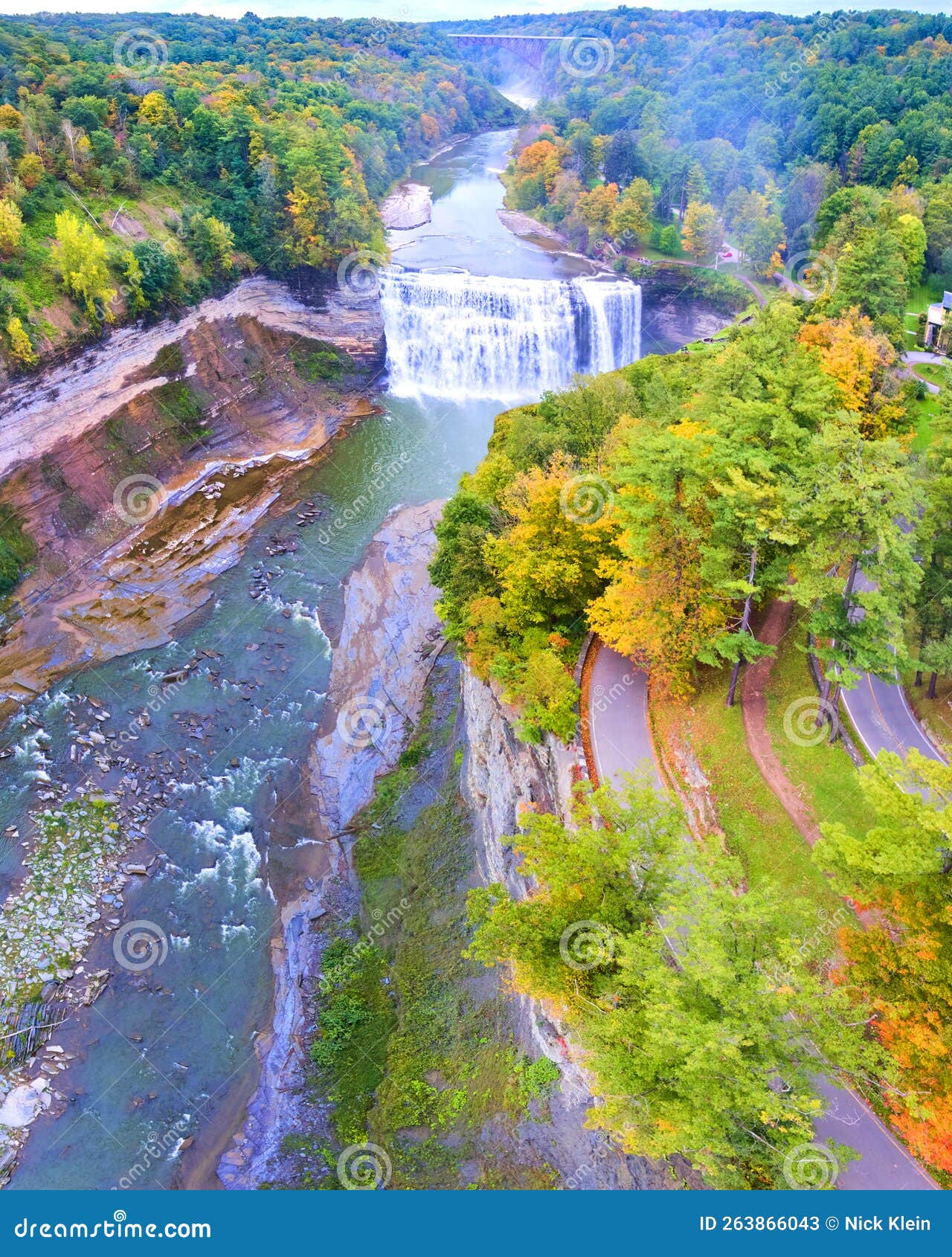 Aerial Panorama Over Road Along Edge of Cliffs with Raging Waterfall ...