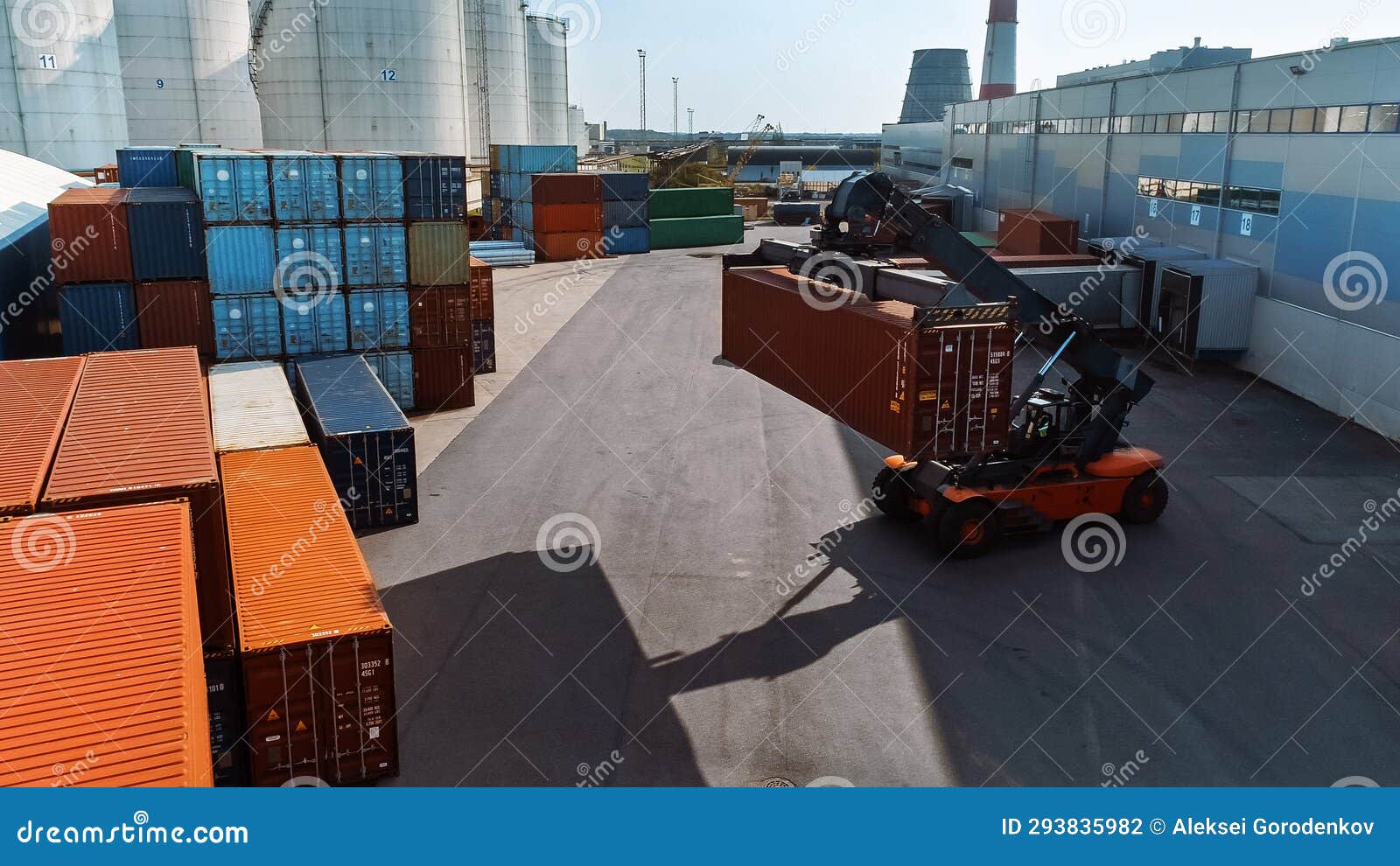 Aerial Shot of a Container Handler Carrying a Large Red Shipping Cargo ...