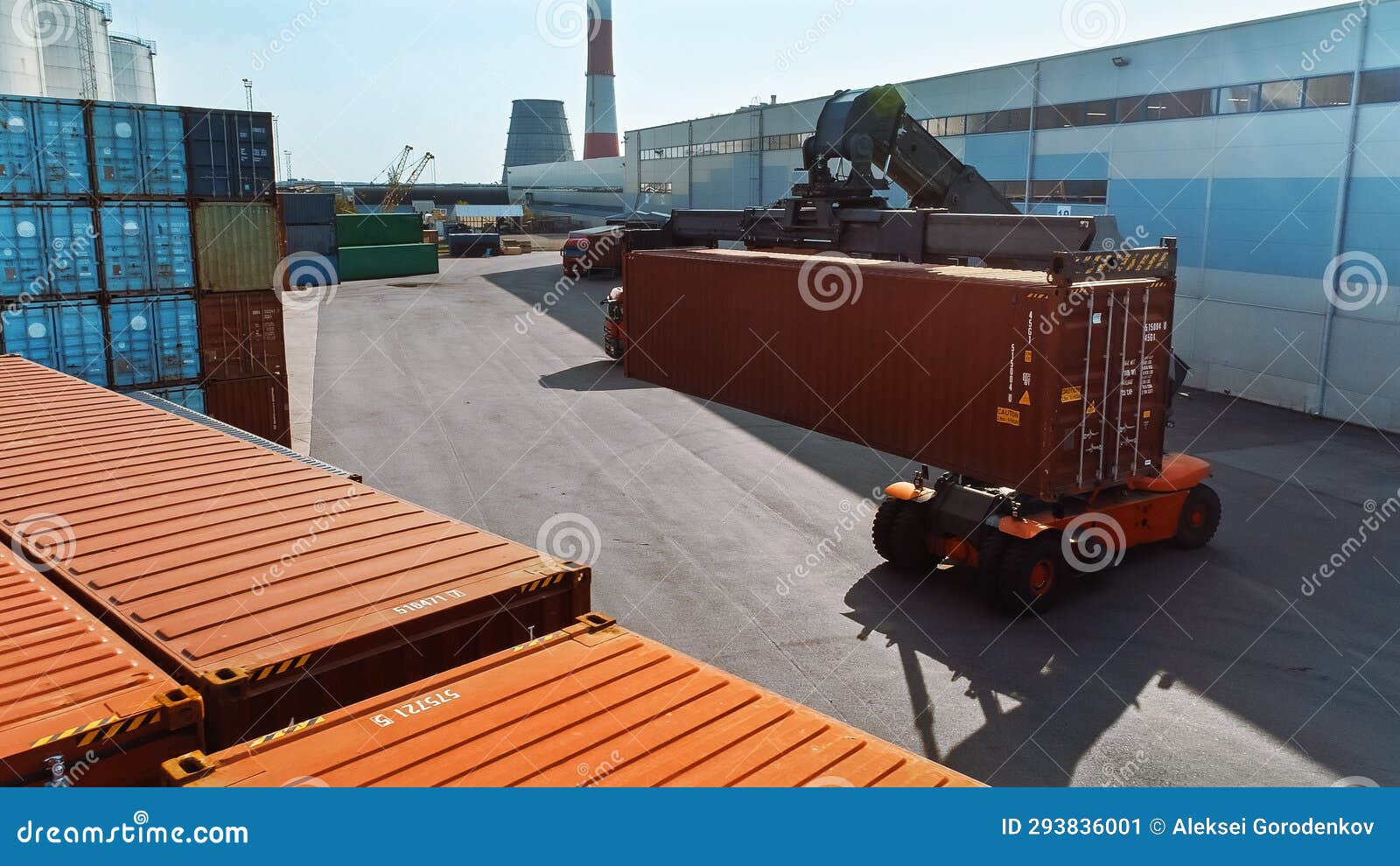 Aerial Shot of a Container Handler Carrying a Large Red Shipping Cargo ...