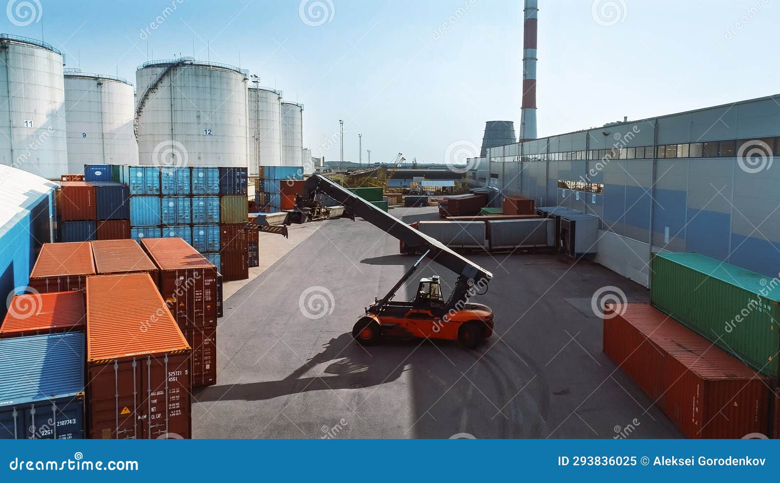 Aerial Shot of a Container Handler Carrying a Large Red Shipping Cargo ...