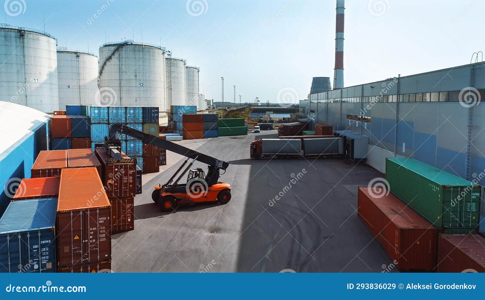 Aerial Shot of a Container Handler Carrying a Large Red Shipping Cargo ...