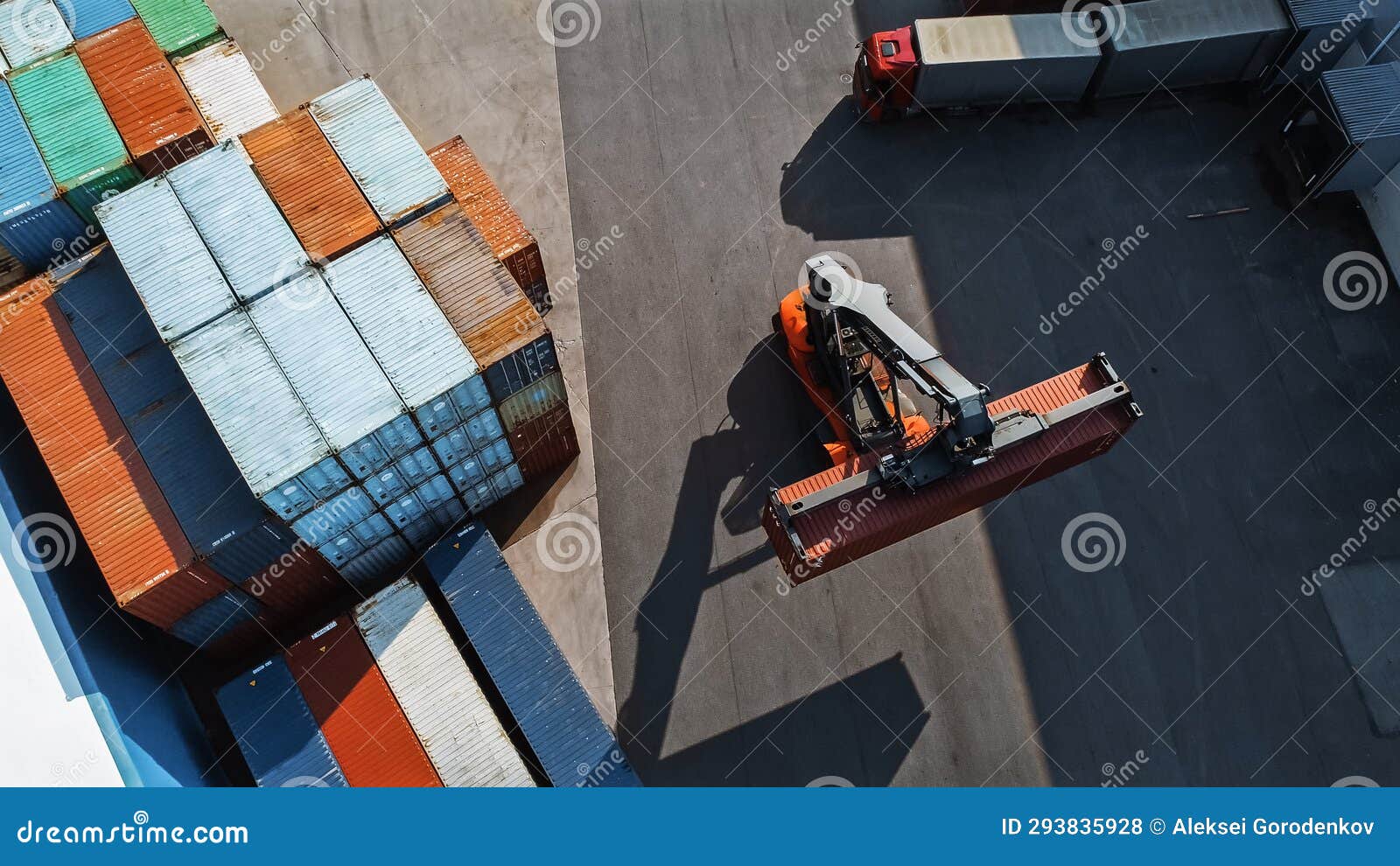 Aerial Top Down Shot of a Container Handler Carrying a Large Red Cargo ...