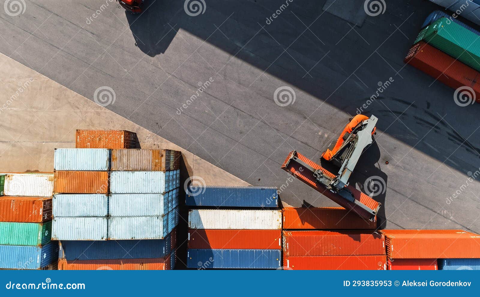Aerial Top Down Shot of a Container Handler Carrying a Large Red Cargo ...