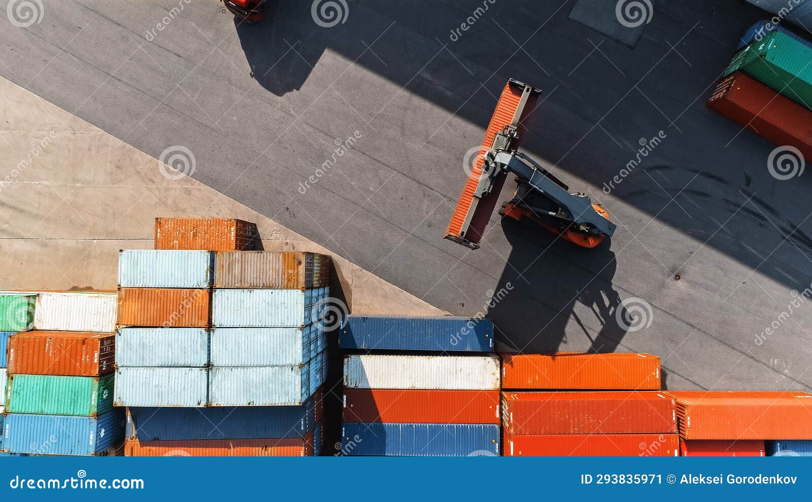 Aerial Top Down Shot of a Container Handler Carrying a Large Red Cargo ...