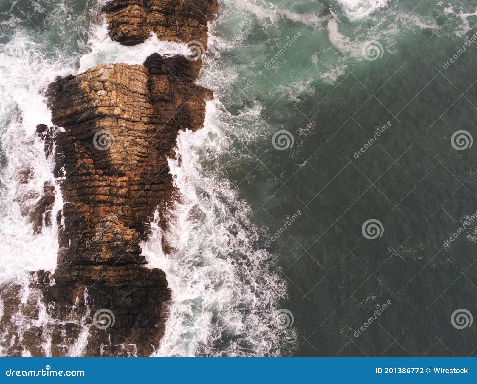 Aerial Top View of Cliffs Surrounded by Wavy Waters - Perfect for ...
