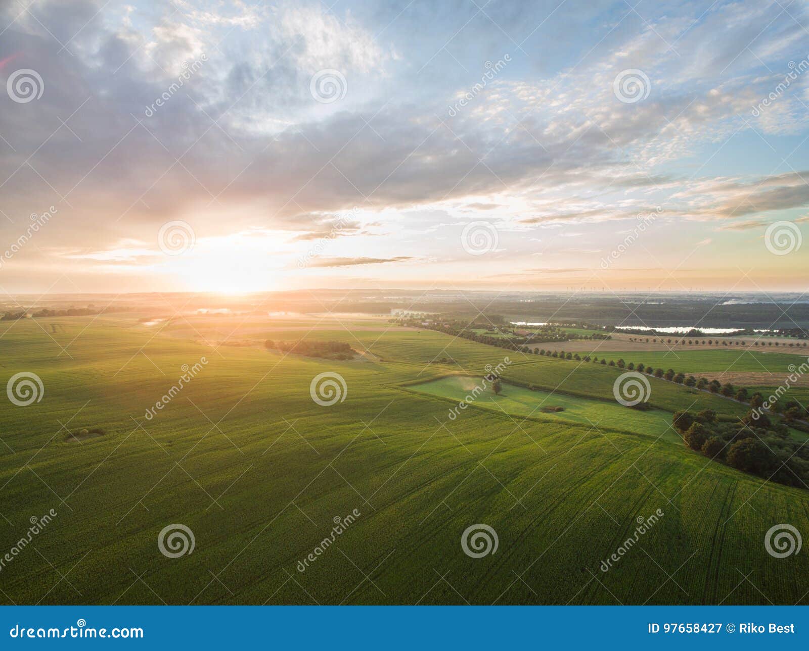 Aerial View of a Beautiful Sunset Over Green Corn Fields - Agricultural ...