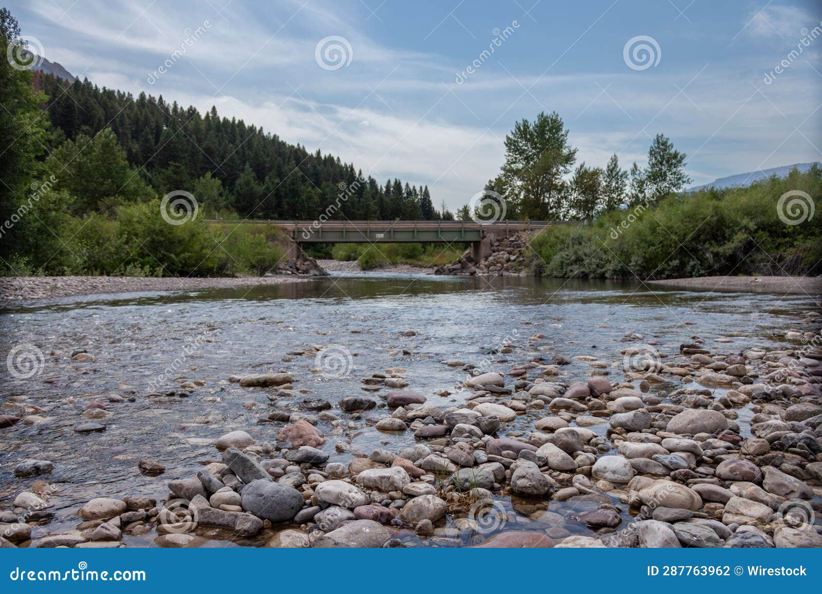 A Bridge Over a River on the Side of the Road Stock Photo - Image of ...