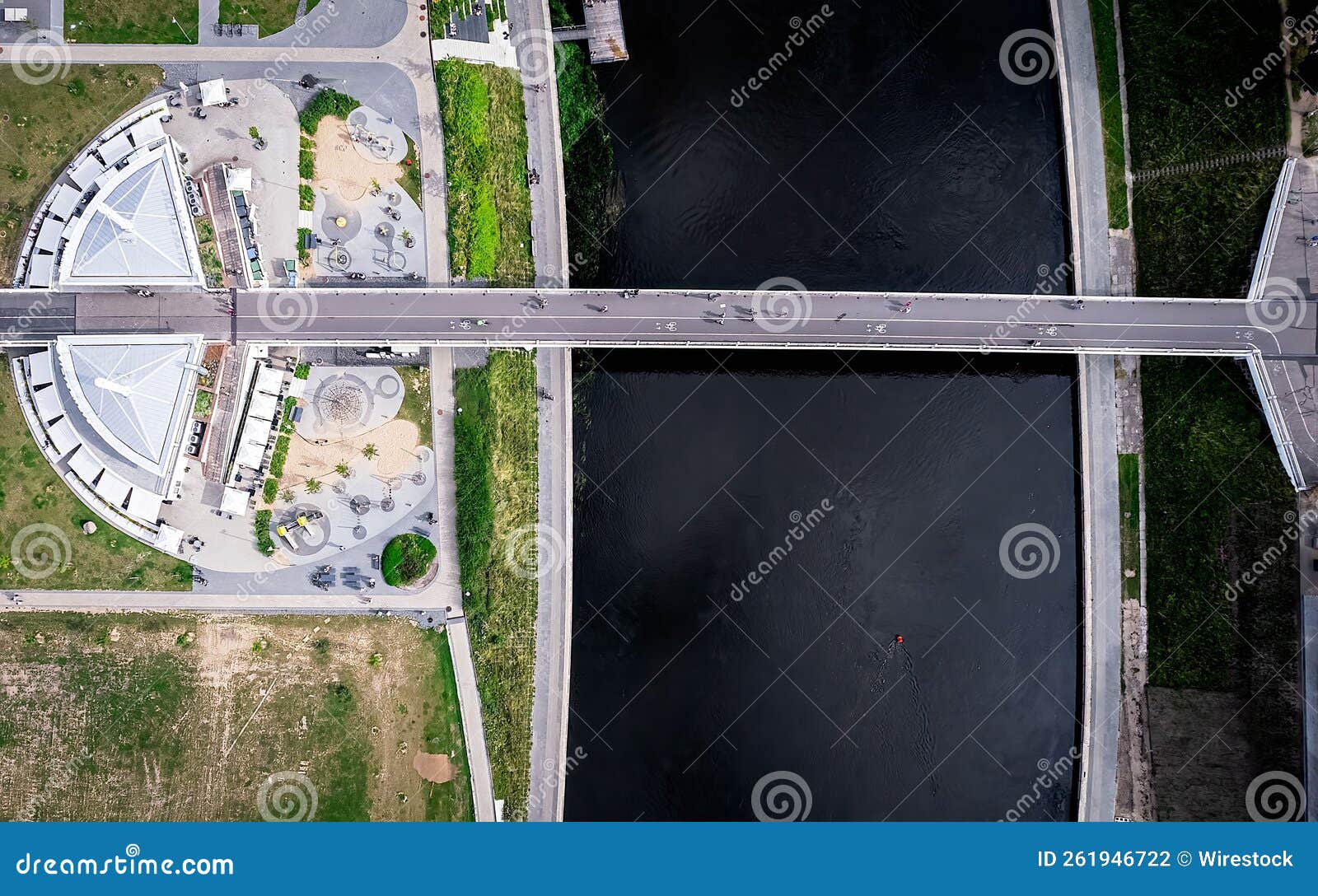 Aerial View of a Bridge Crossing Over a River and a Complex Building ...