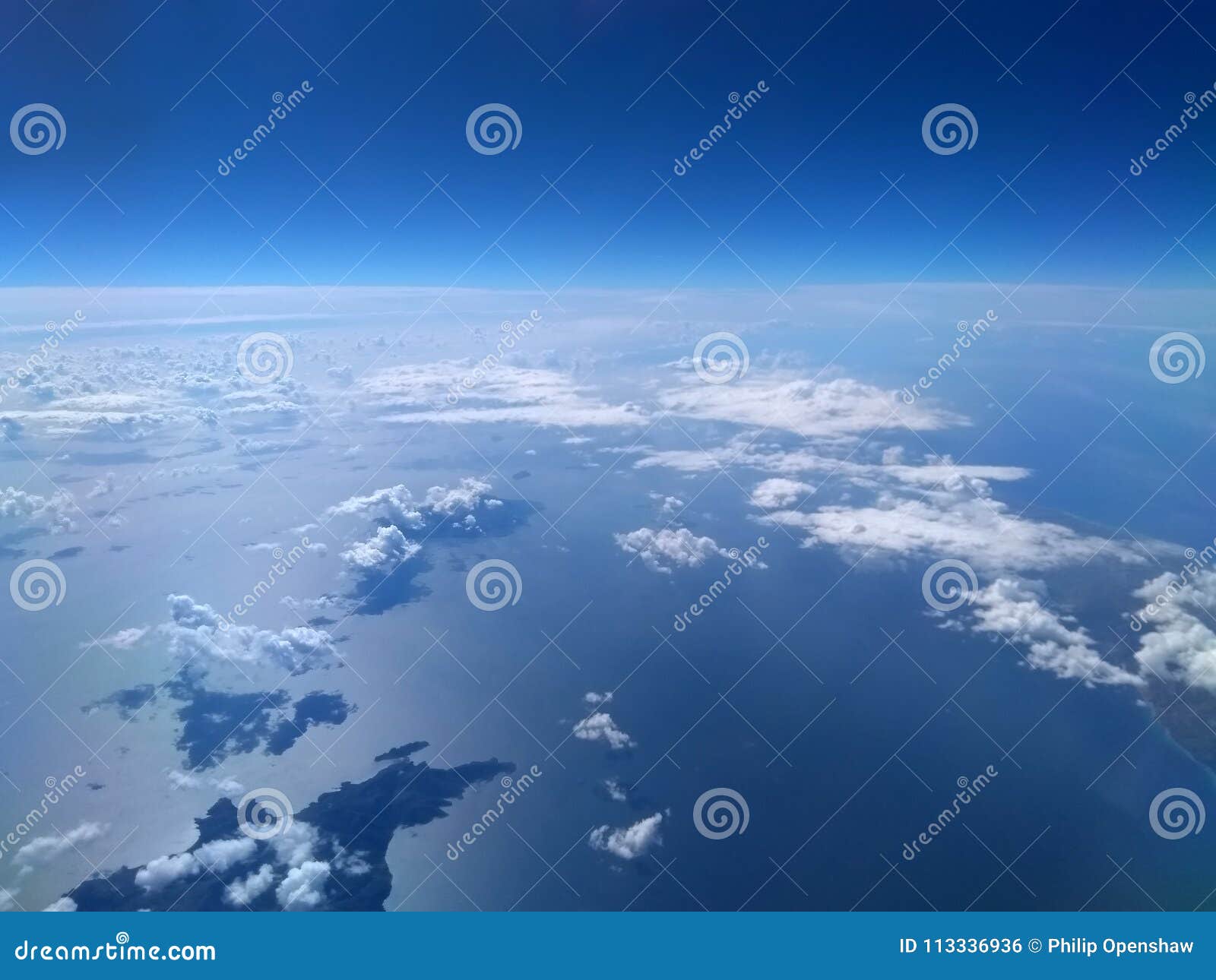 Aerial View of Bright Blue Sea and Sky with White Clouds Casting ...