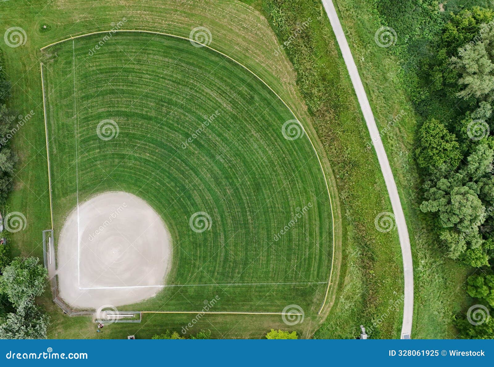 Aerial View of an Empty Baseball Field Surrounded by Greenery and a ...