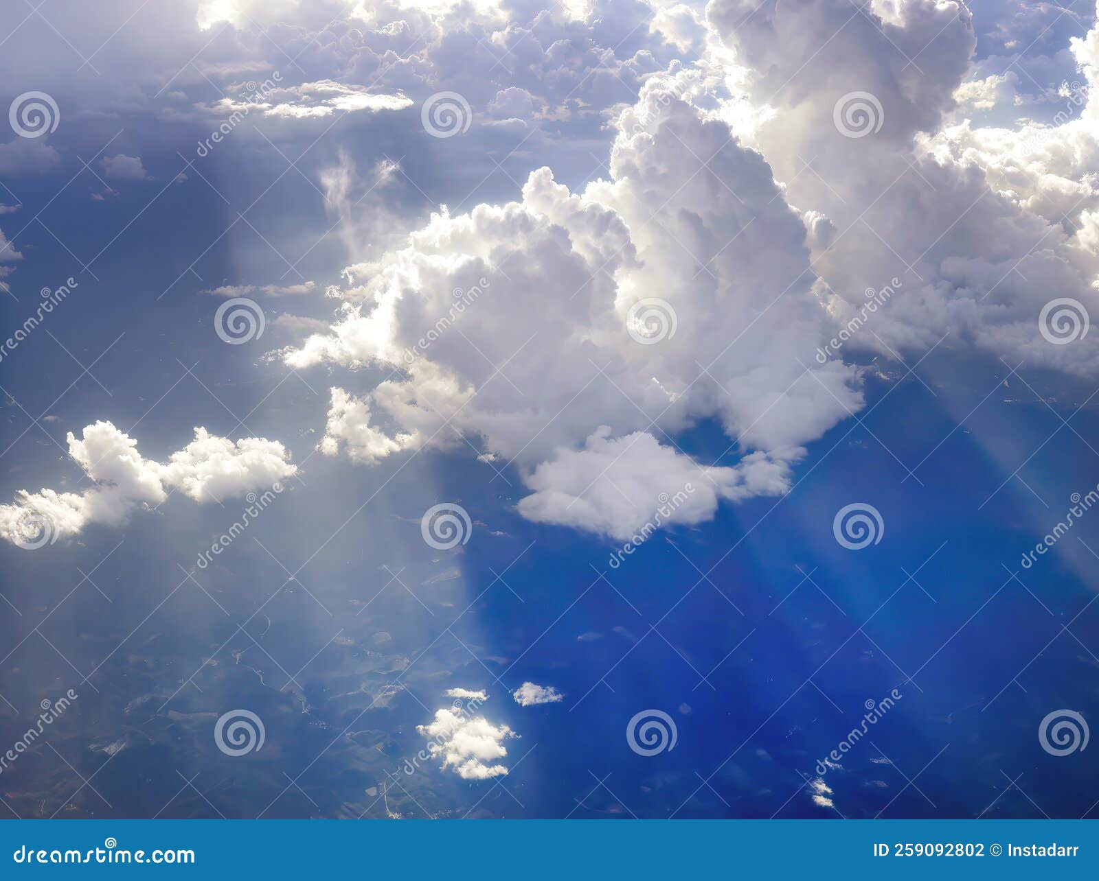 Aerial View Flying Above Dramatic Fluffy Clouds and Sun Rays Piercing ...