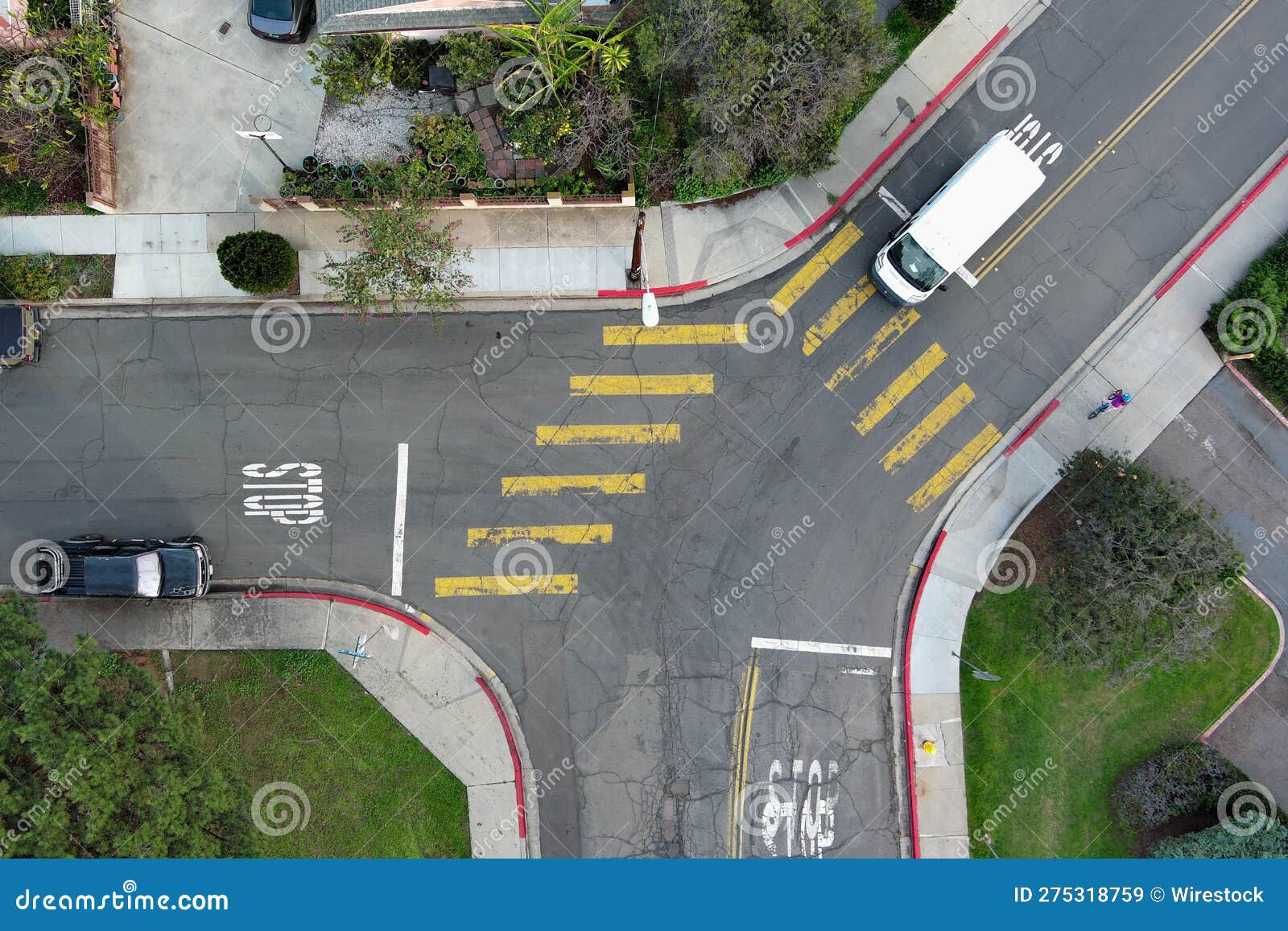 Aerial View of an Intersection Surrounded by Greenery in the Daylight ...