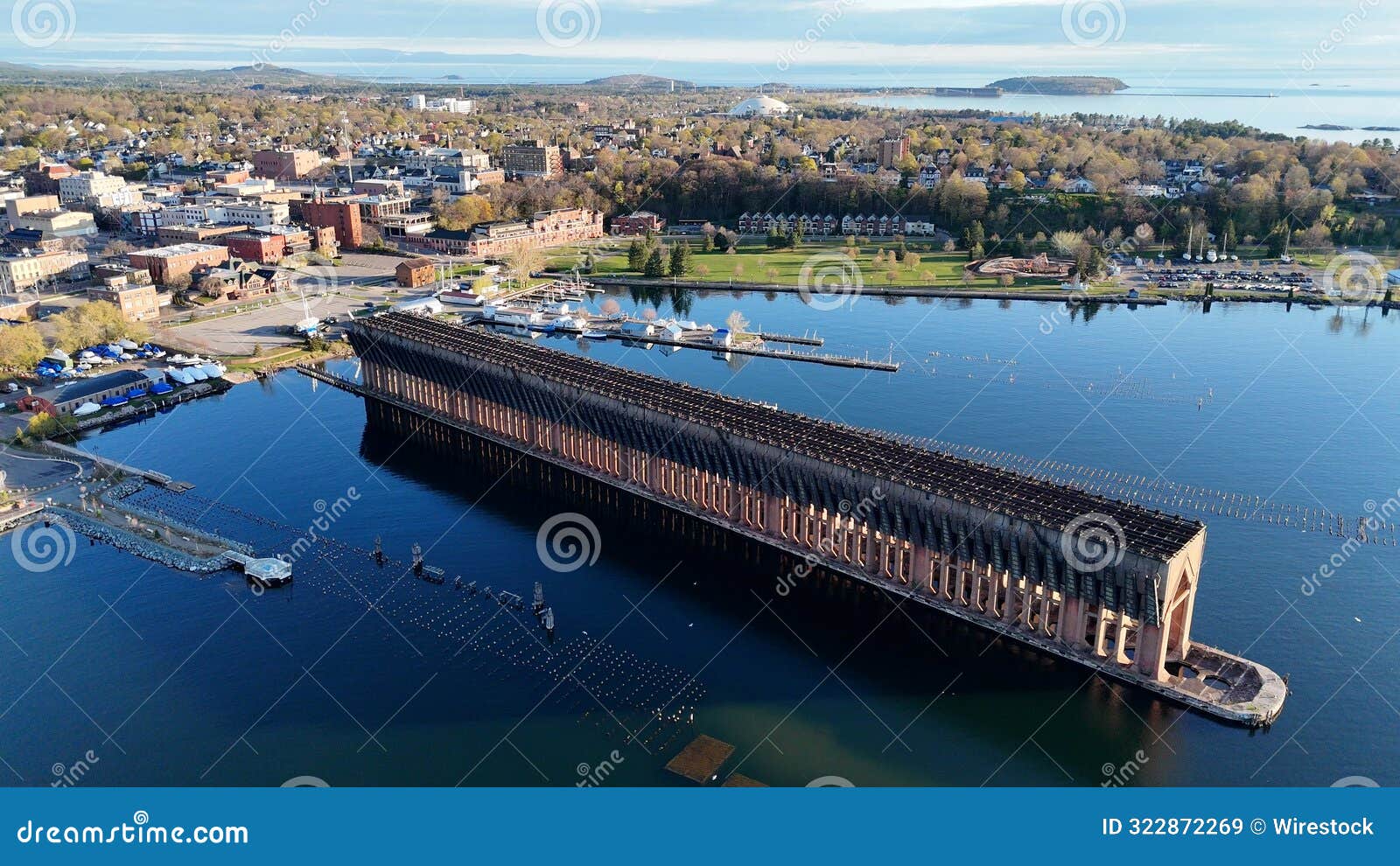 Aerial View Large Dock with Arch Structures with a Cityscape and Forest ...