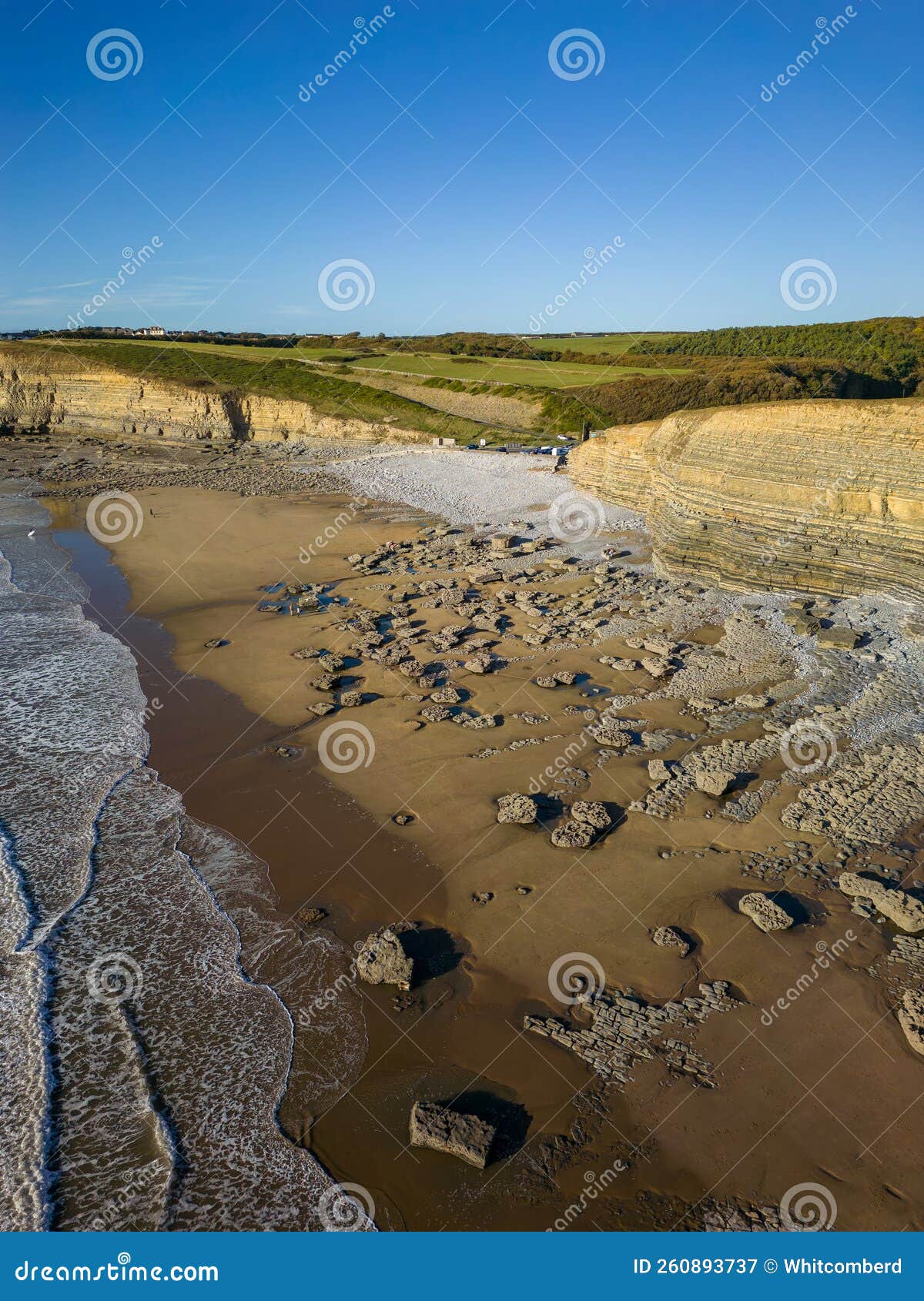 Aerial View of Large Limestone Cliffs and a Sandy Beach Next To the Sea ...