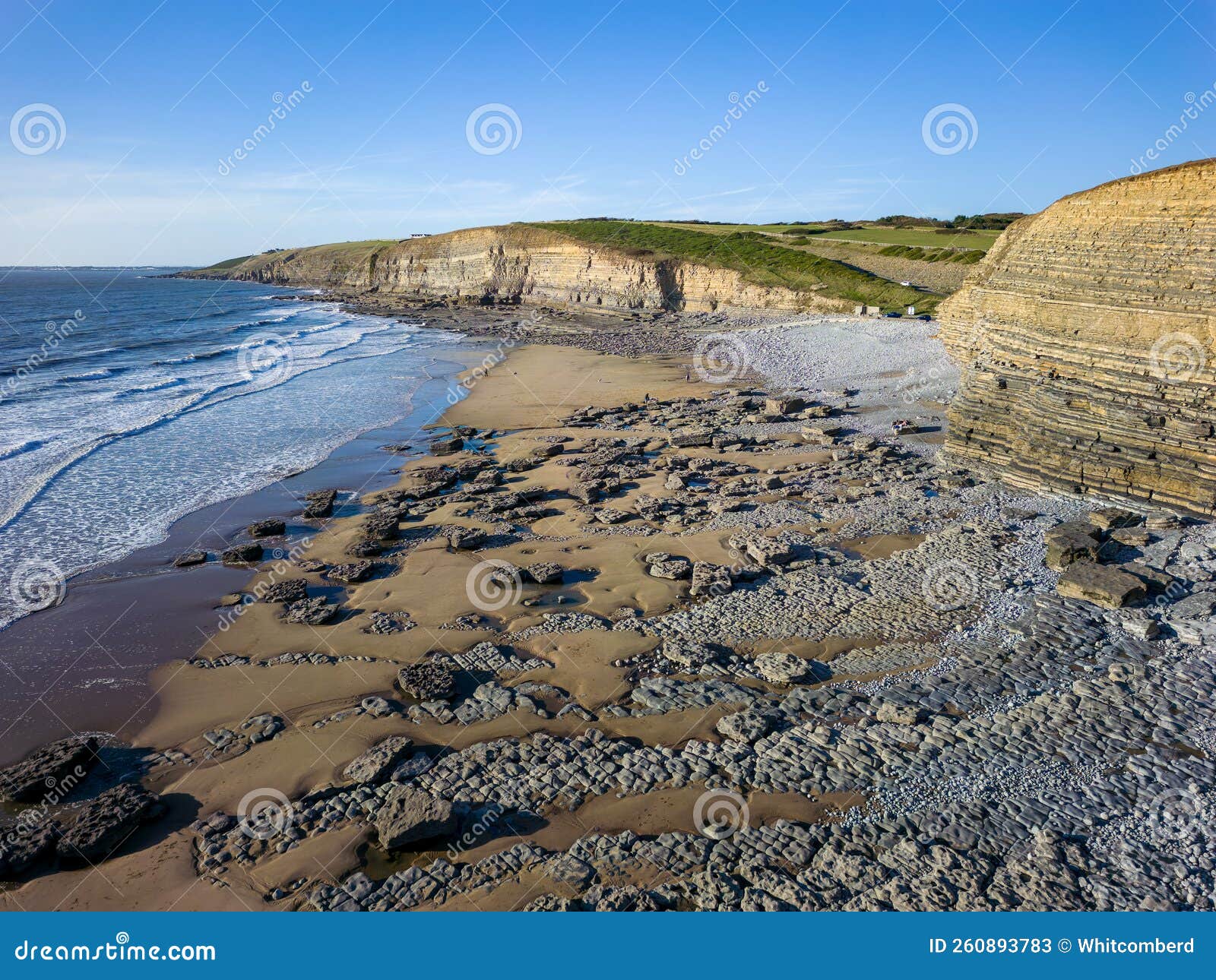 Aerial View of Large Limestone Cliffs and a Sandy Beach Next To the Sea ...