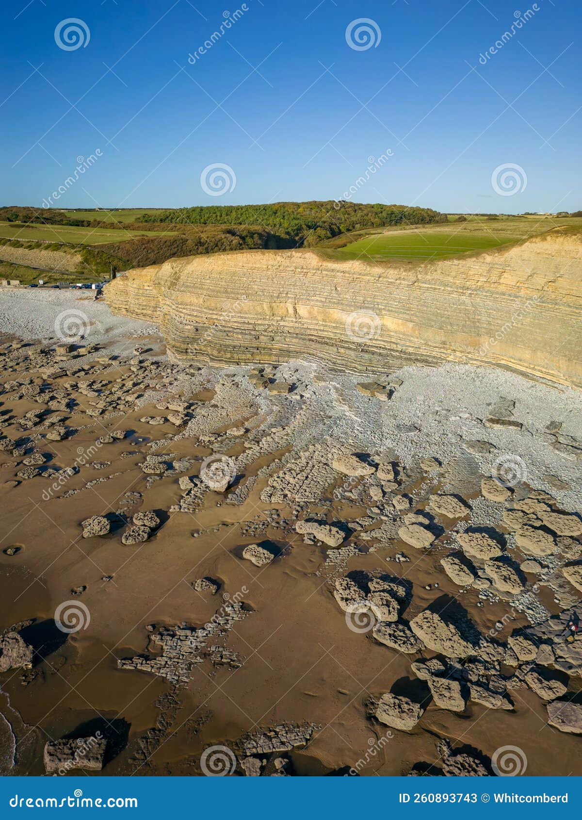 Aerial View of Limestone Cliffs and a Rock Covered Sandy Beach Stock ...
