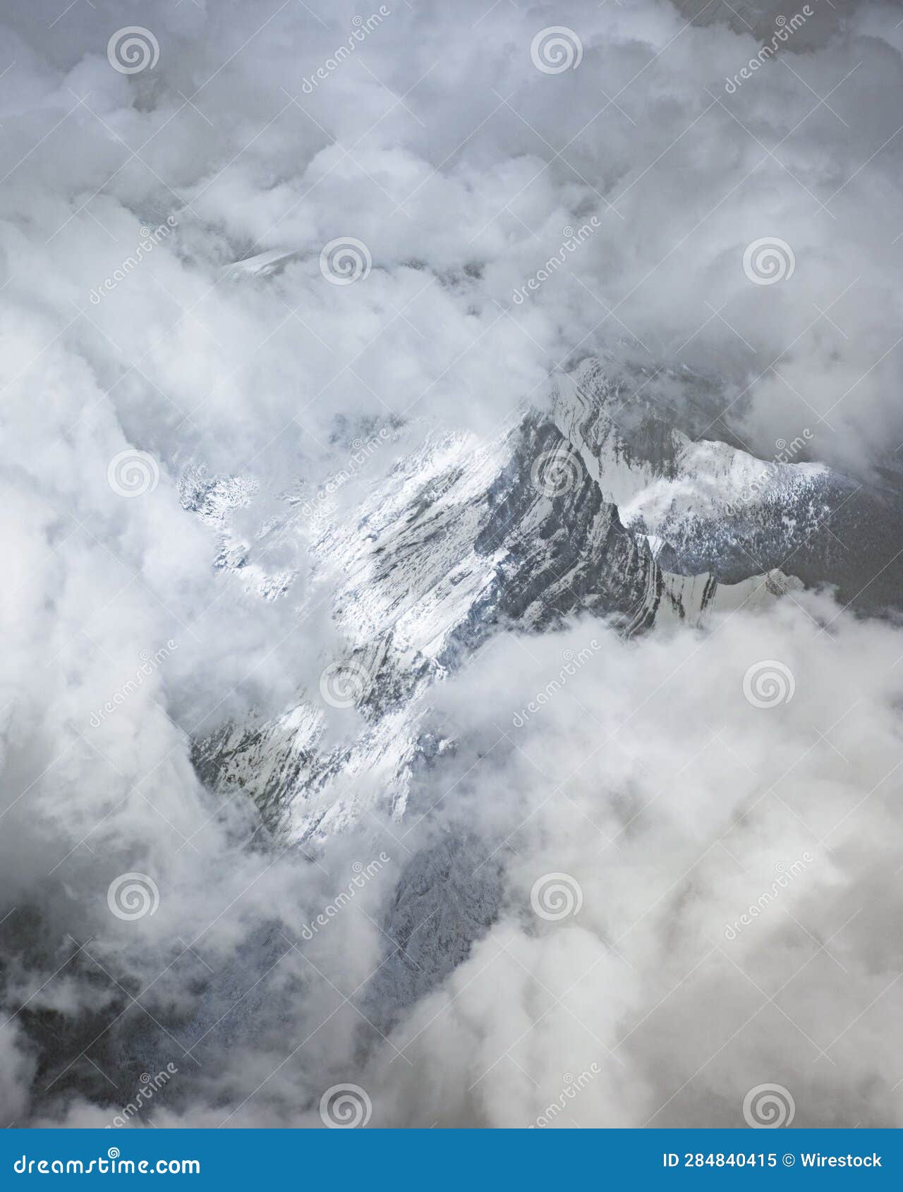 Aerial View of Mountain Peaks Shrouded in Clouds Stock Image - Image of ...