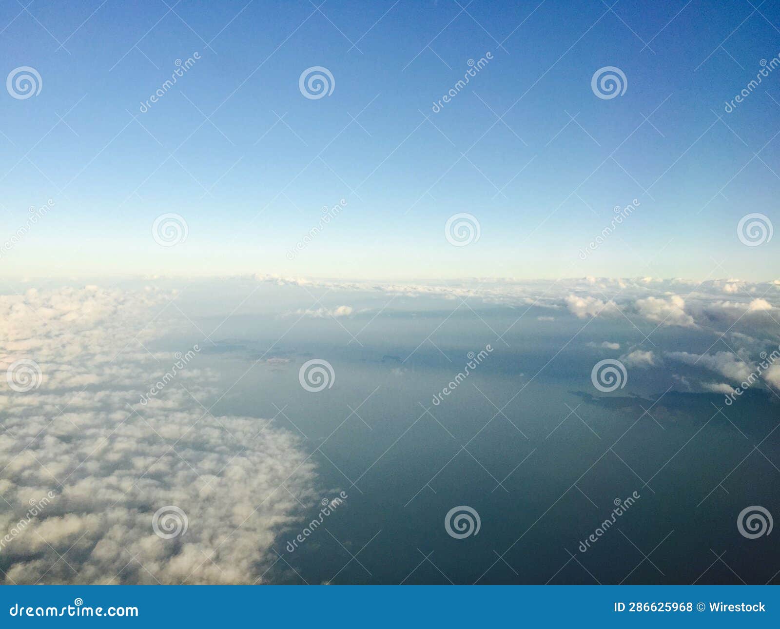 Aerial View of the Ocean S Surface with Billowing Clouds Above Stock ...