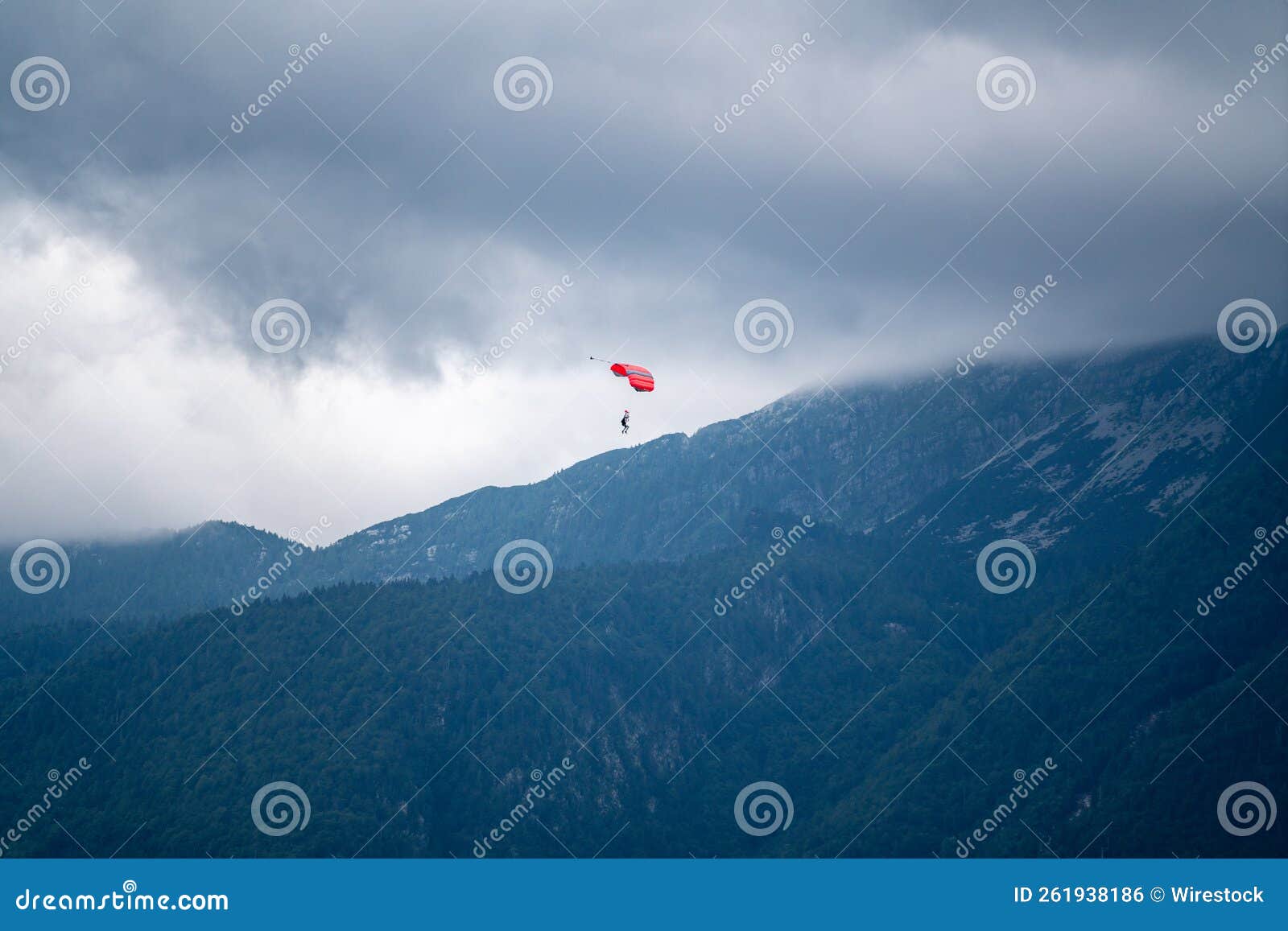Aerial View of Parachute Flying Over Mountains Surrounded by Dense ...