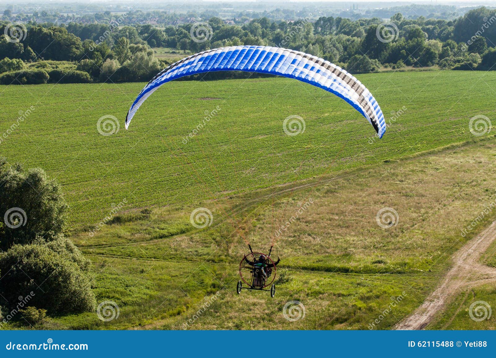Aerial View of Paramotor Flying Over the Fields Stock Photo - Image of ...