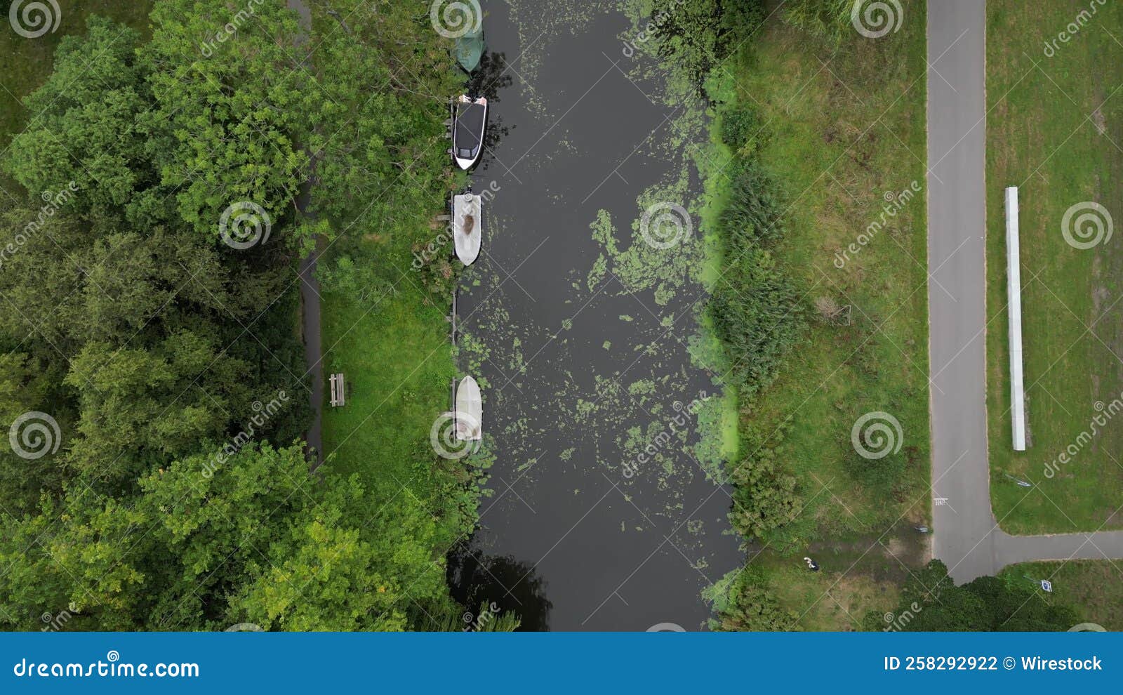 Aerial View of a Path Alongside a Small Waterway with Parked Boats ...