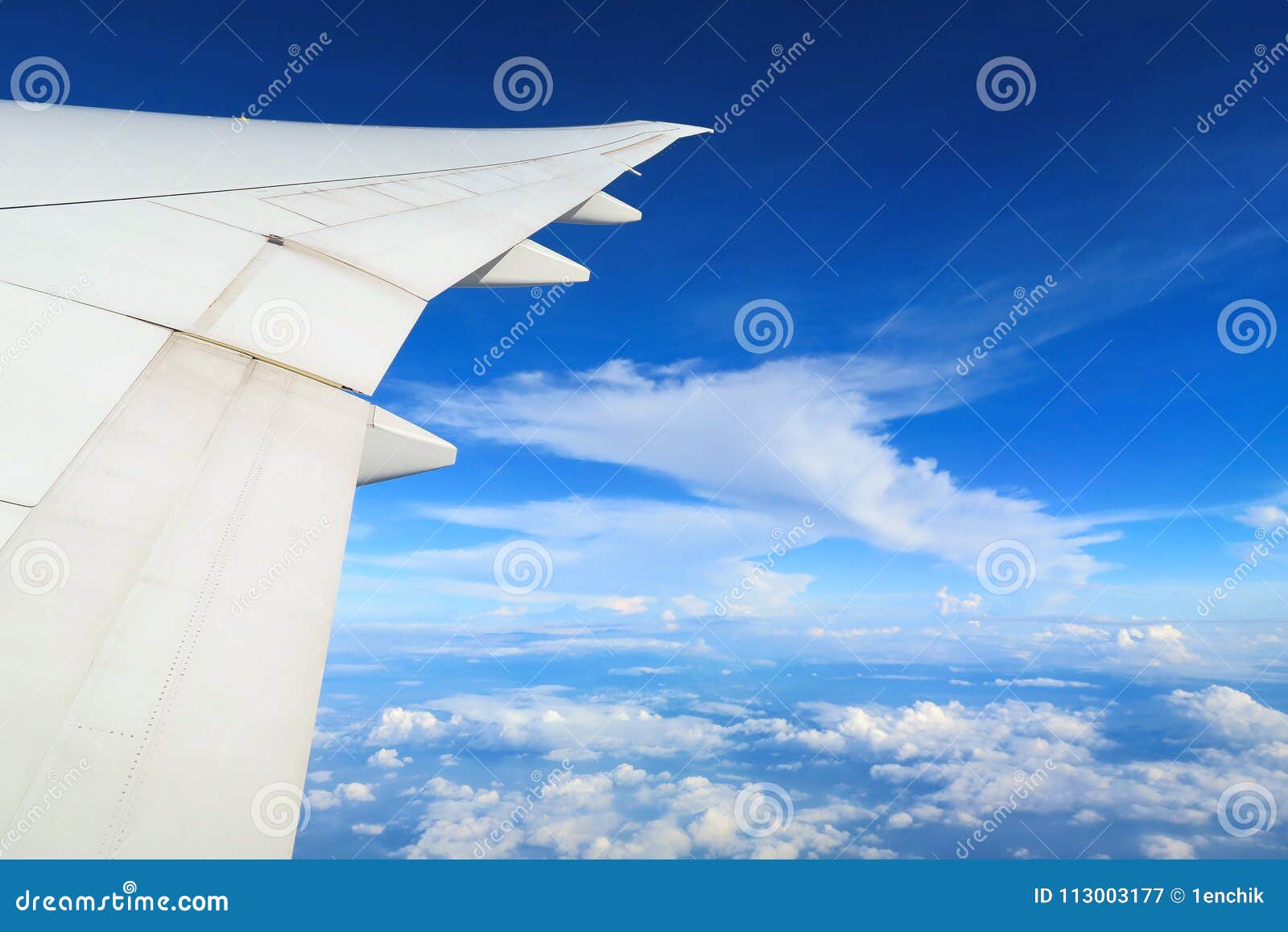 Aerial View of Plane Window Above Clouds Under Blue Sky. View from ...