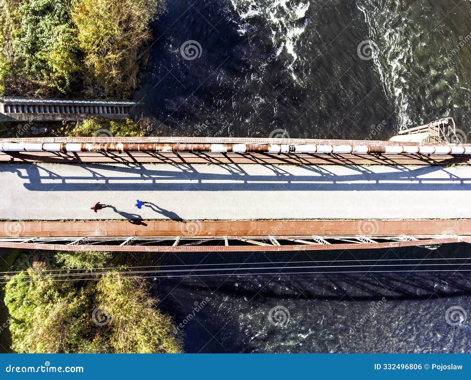 Aerial View of a Runner Running Across Bridge Over the River. Morning ...