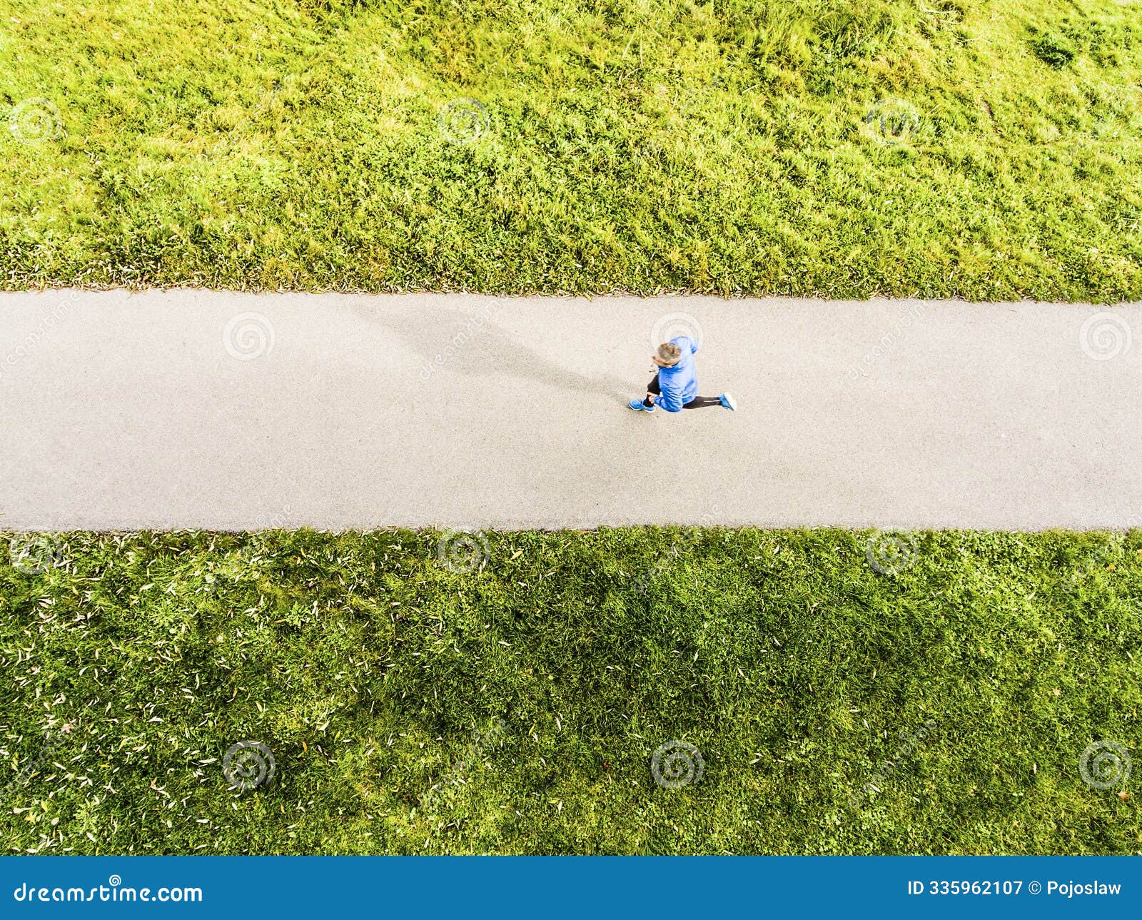 Aerial View of a Runner Running through Autumn Park on Jogging Path ...