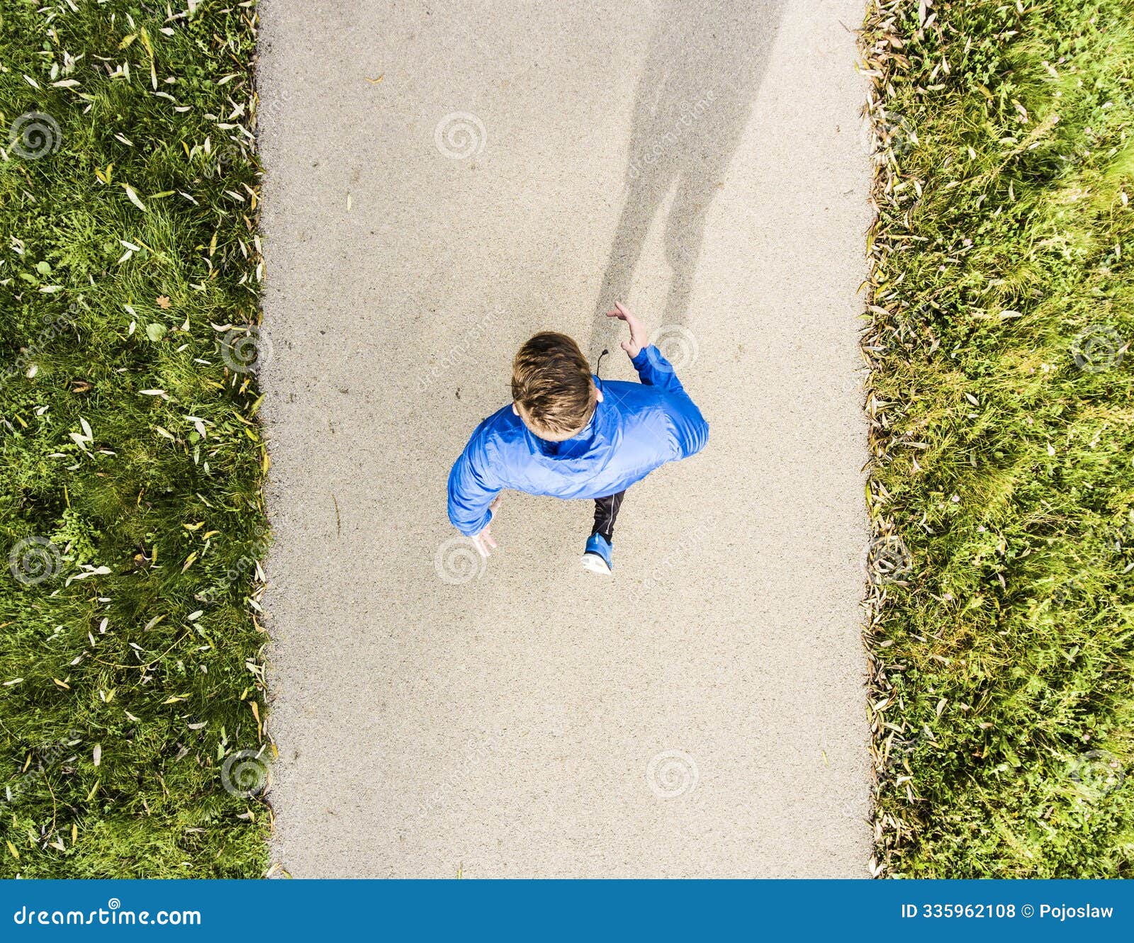 Aerial View of a Runner Running through Autumn Park on Jogging Path ...
