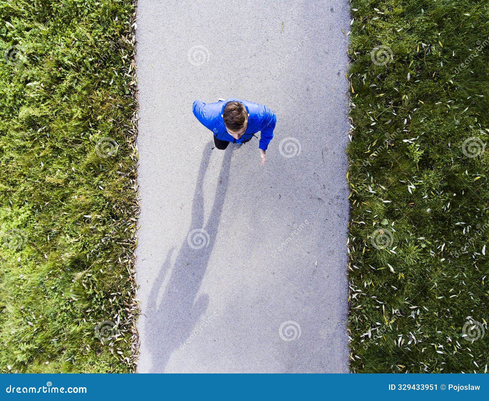 Aerial View of a Runner Running through the Park on a Jogging Path ...