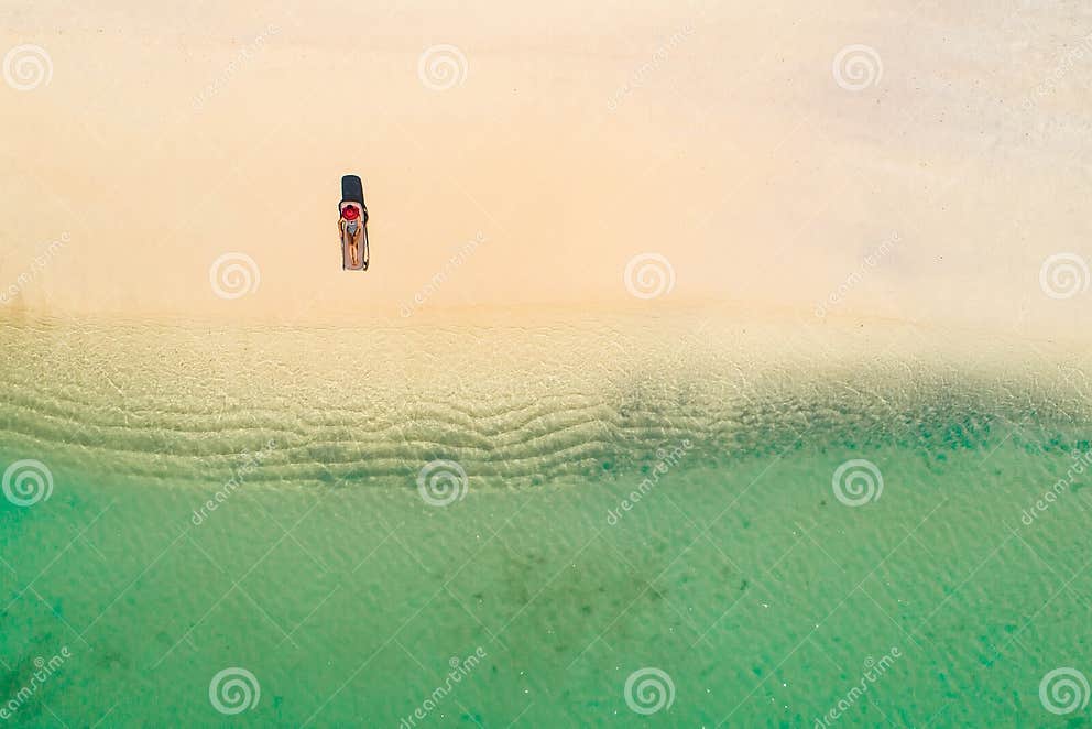 Aerial View Of Slim Woman Sunbathing Lying On A Beach Chairin