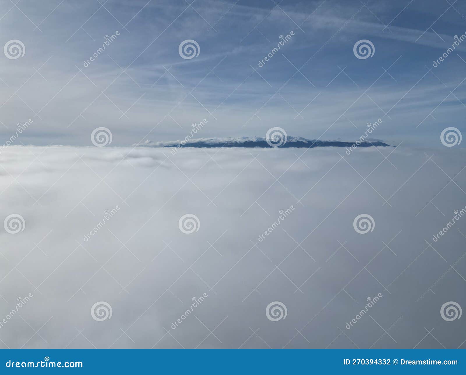 Aerial View of a Snow-covered Mountain Peaking through Dense and Fluffy ...