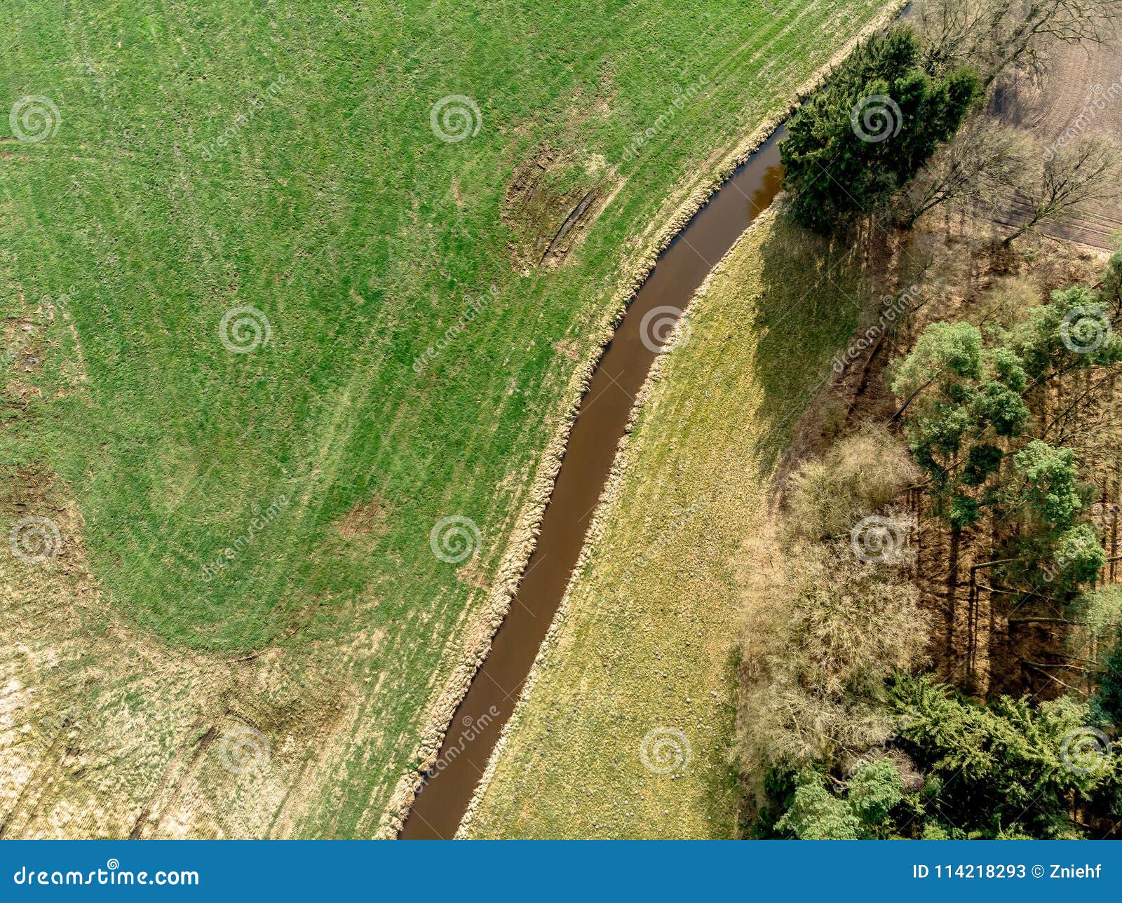 Aerial View of a Stream Flowing through Meadows and Fields with a Small ...