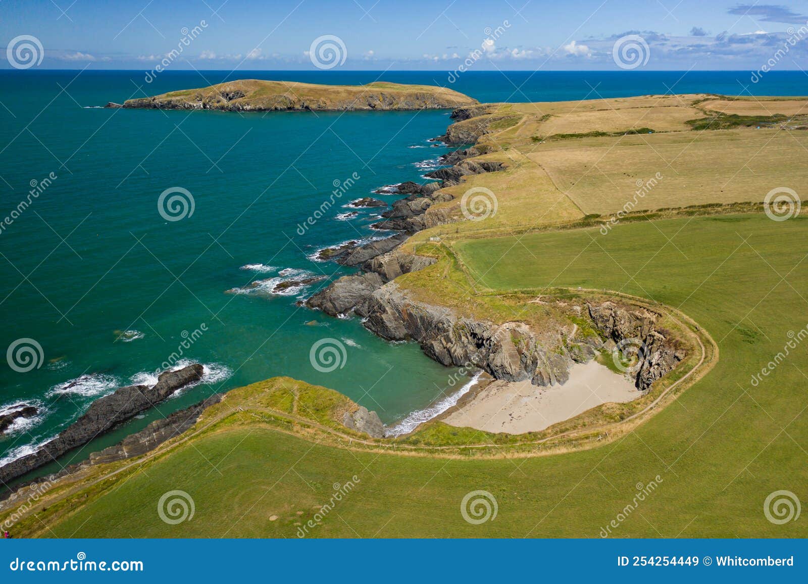 Aerial View of a Tiny Sandy Beach Surrounded by Cliffs on the Coast of ...