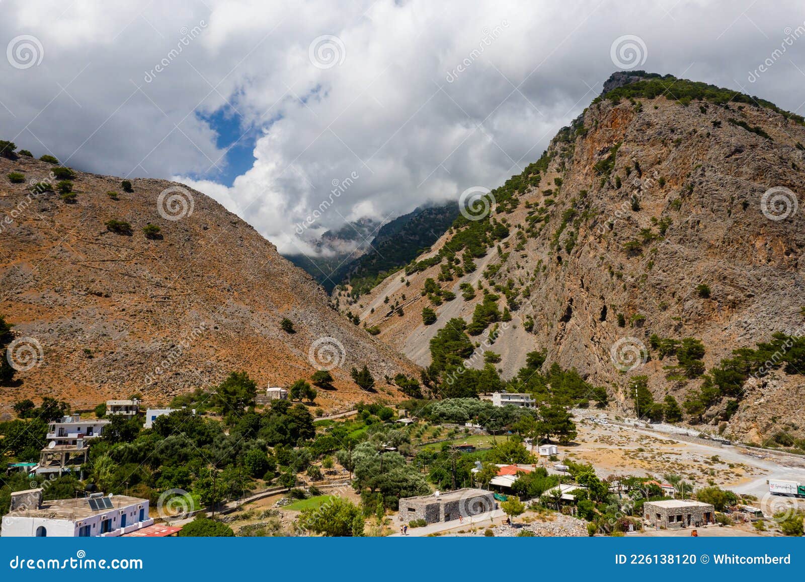 Aerial View of Towering, Cloud Covered Mountains at the Exit of the ...